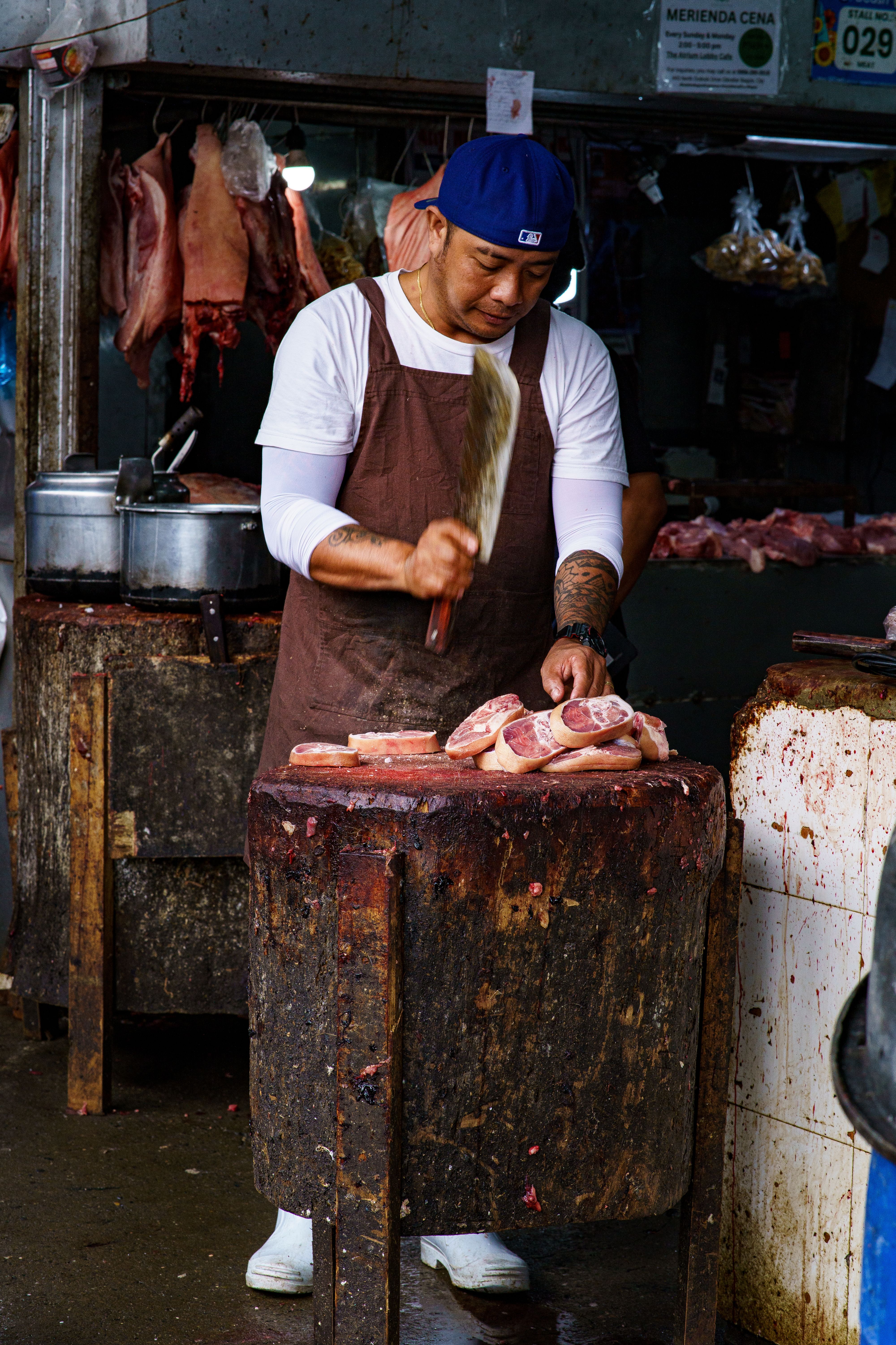 Butcher Preparing Meat in Traditional Market · Free Stock Photo