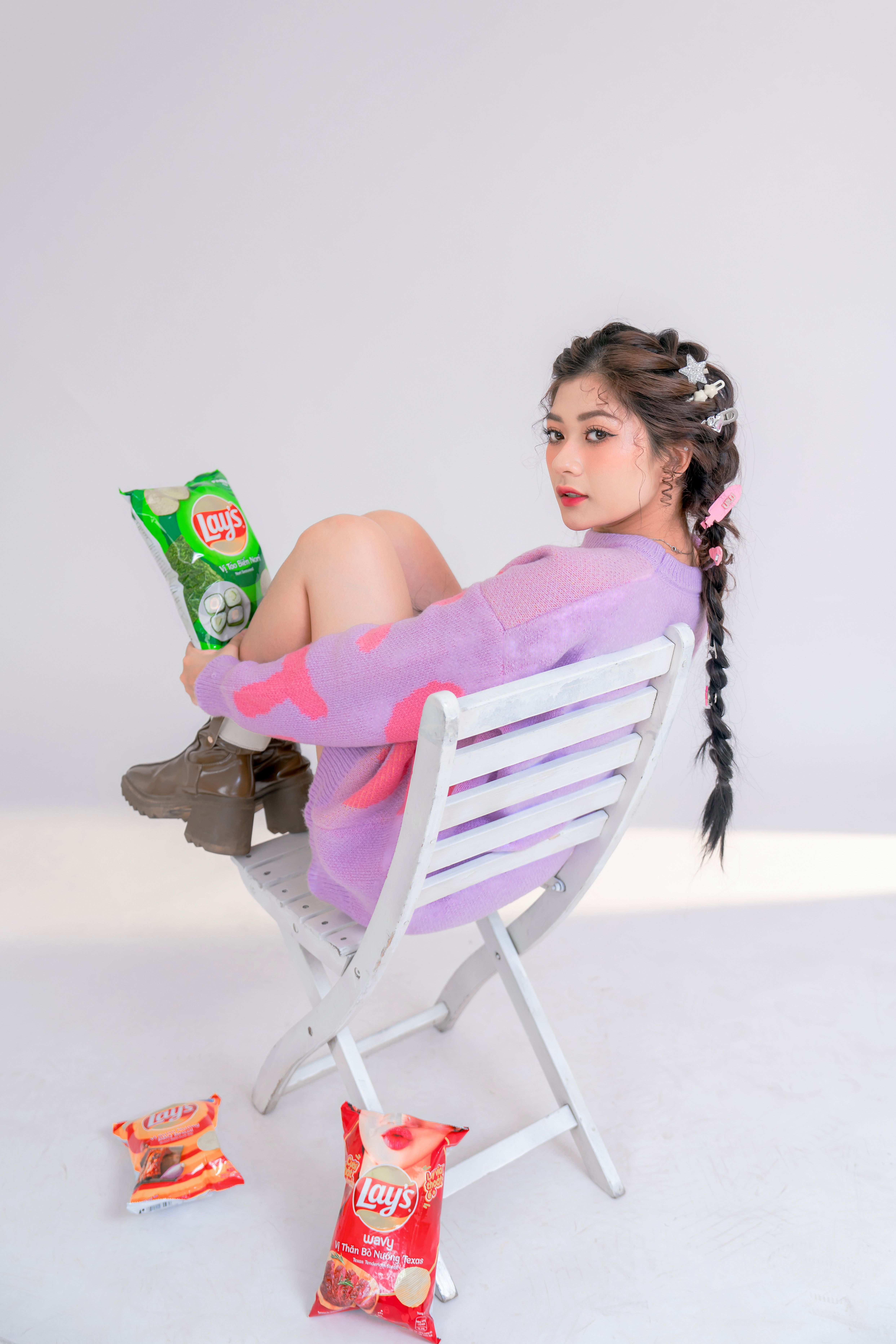 Young Woman Relaxing Indoors with Snacks · Free Stock Photo