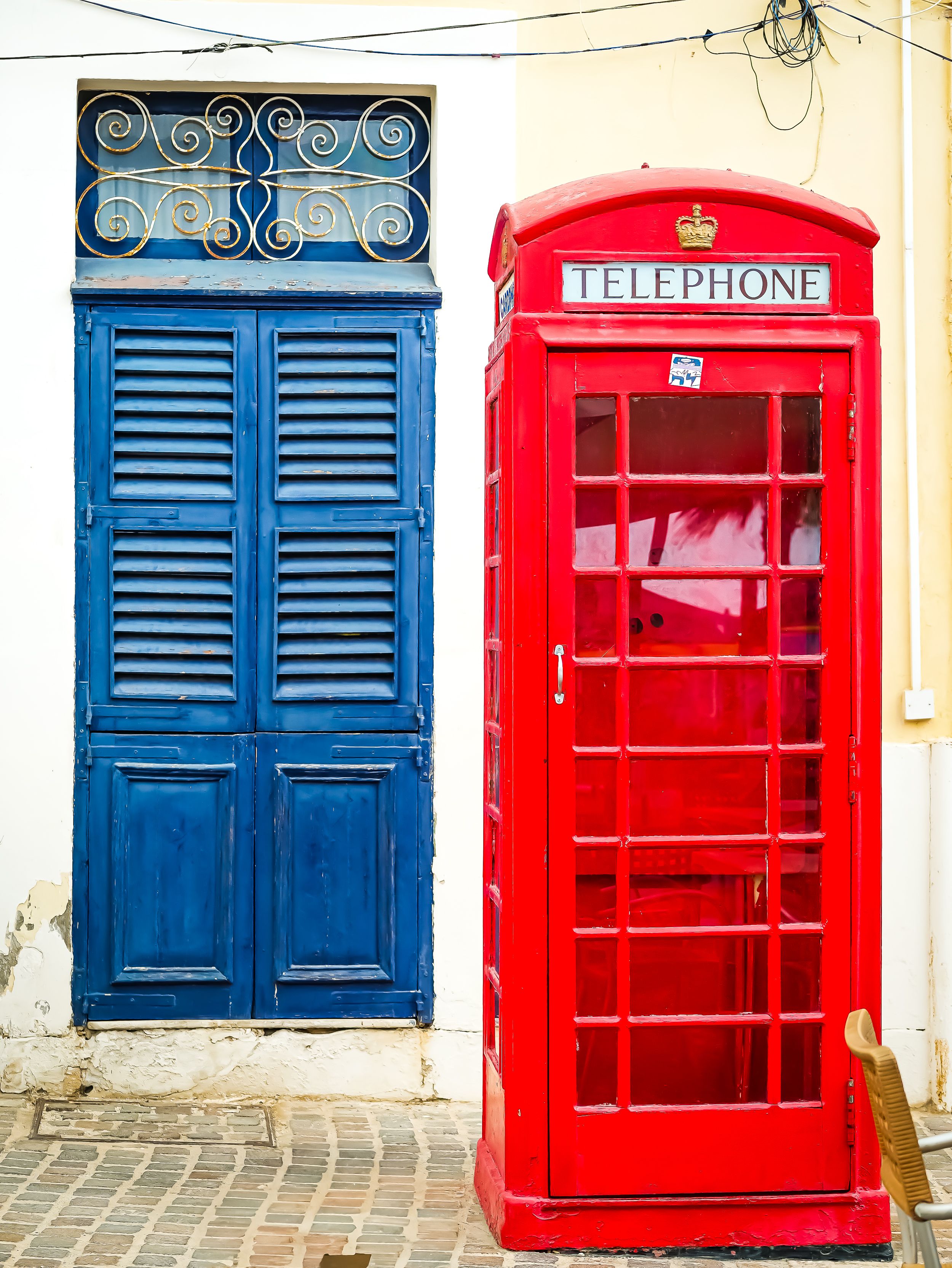 Vintage Red Telephone Booth Beside Blue Door · Free Stock Photo