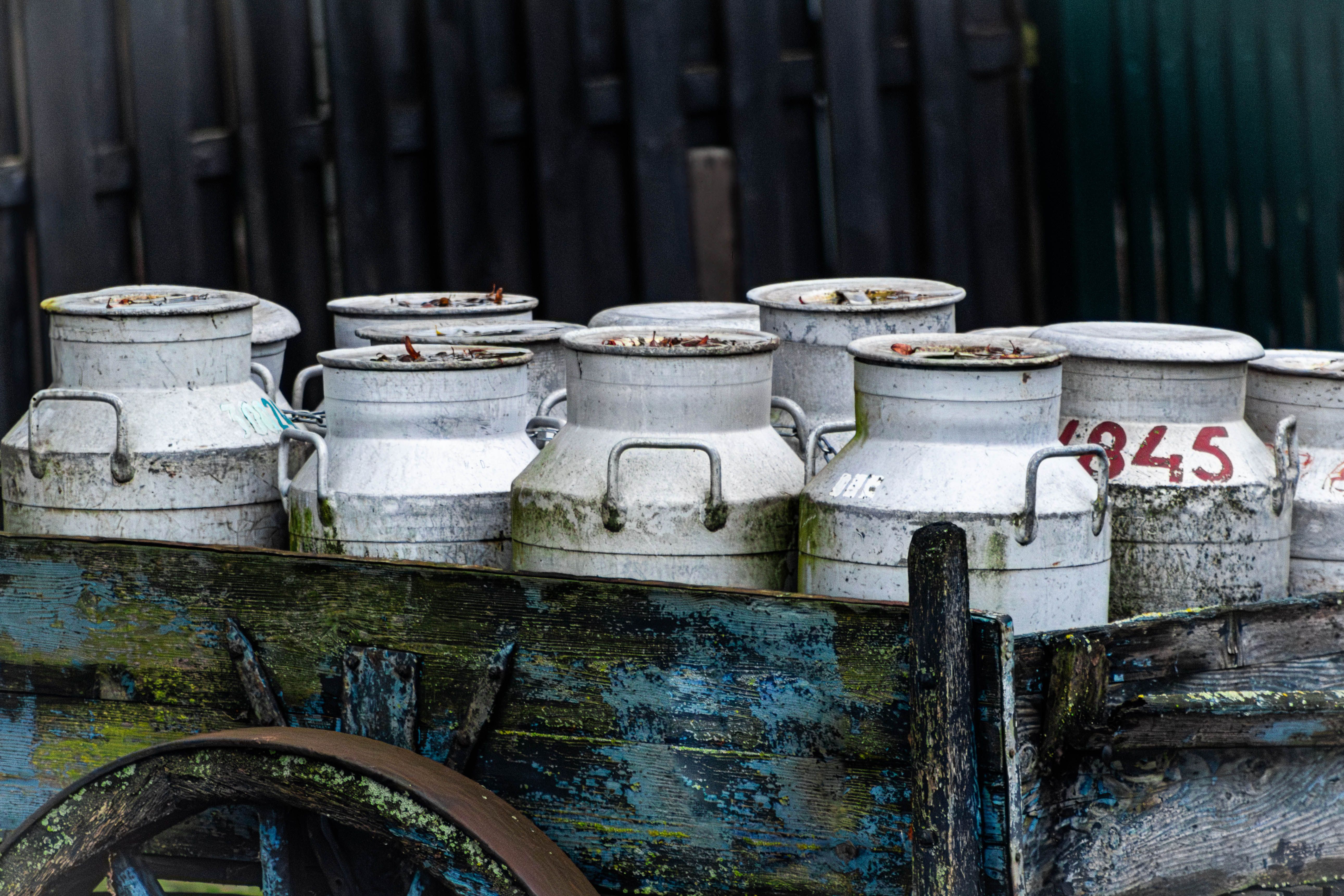 Vintage Milk Cans on Rustic Wooden Cart · Free Stock Photo