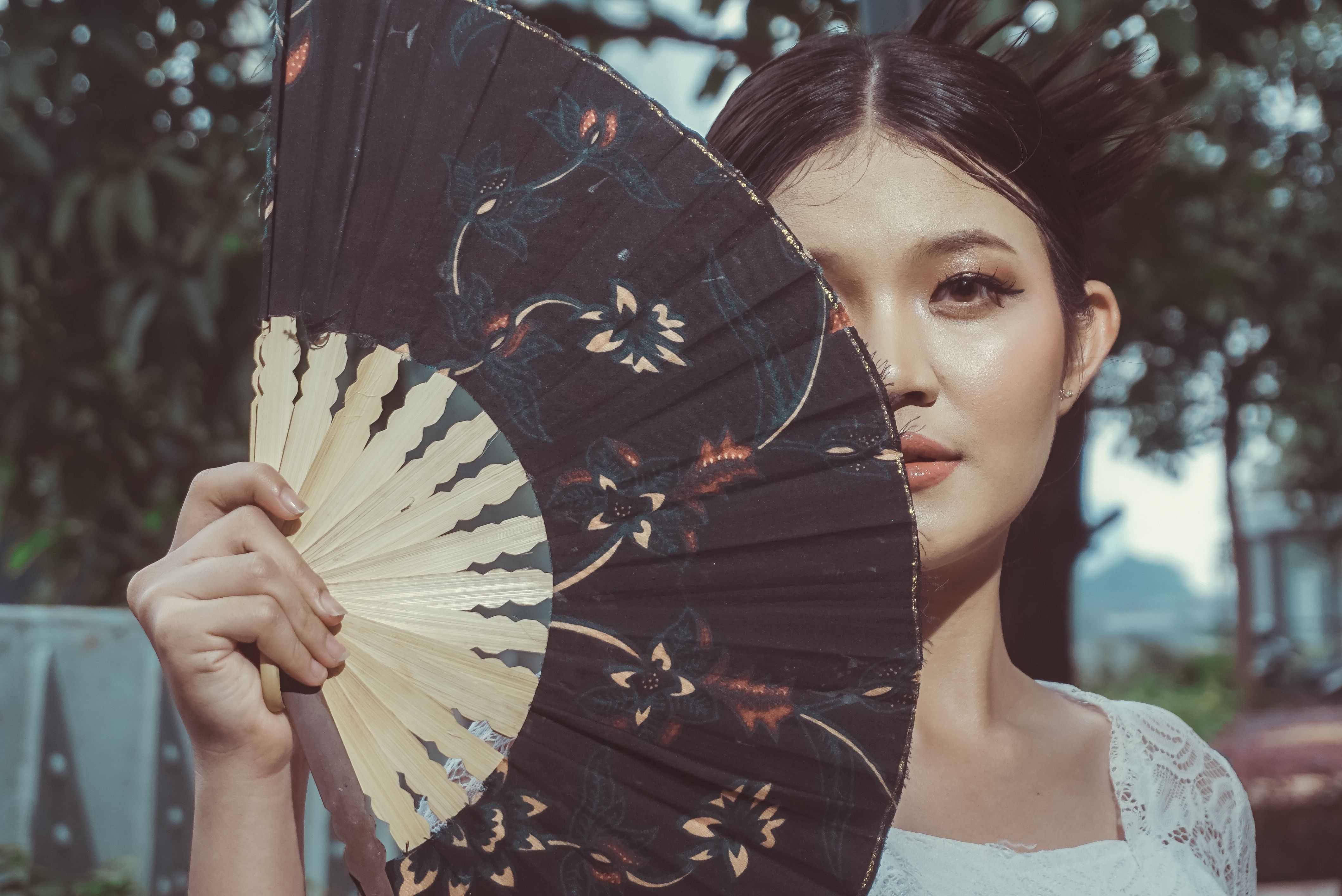 Portrait of Woman with Decorative Hand Fan in Jakarta · Free Stock Photo