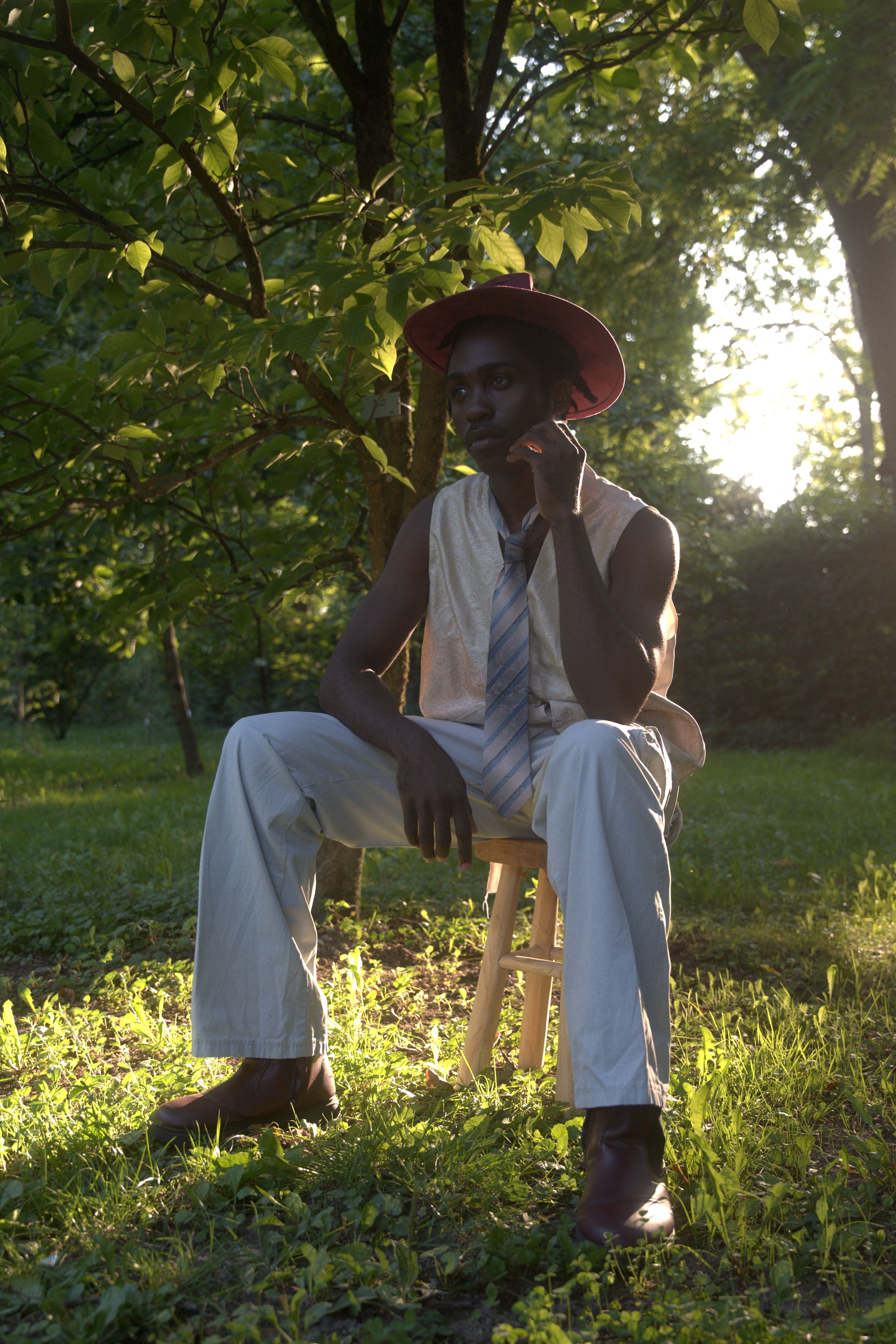 Man Sitting on Bench in a Park Setting · Free Stock Photo