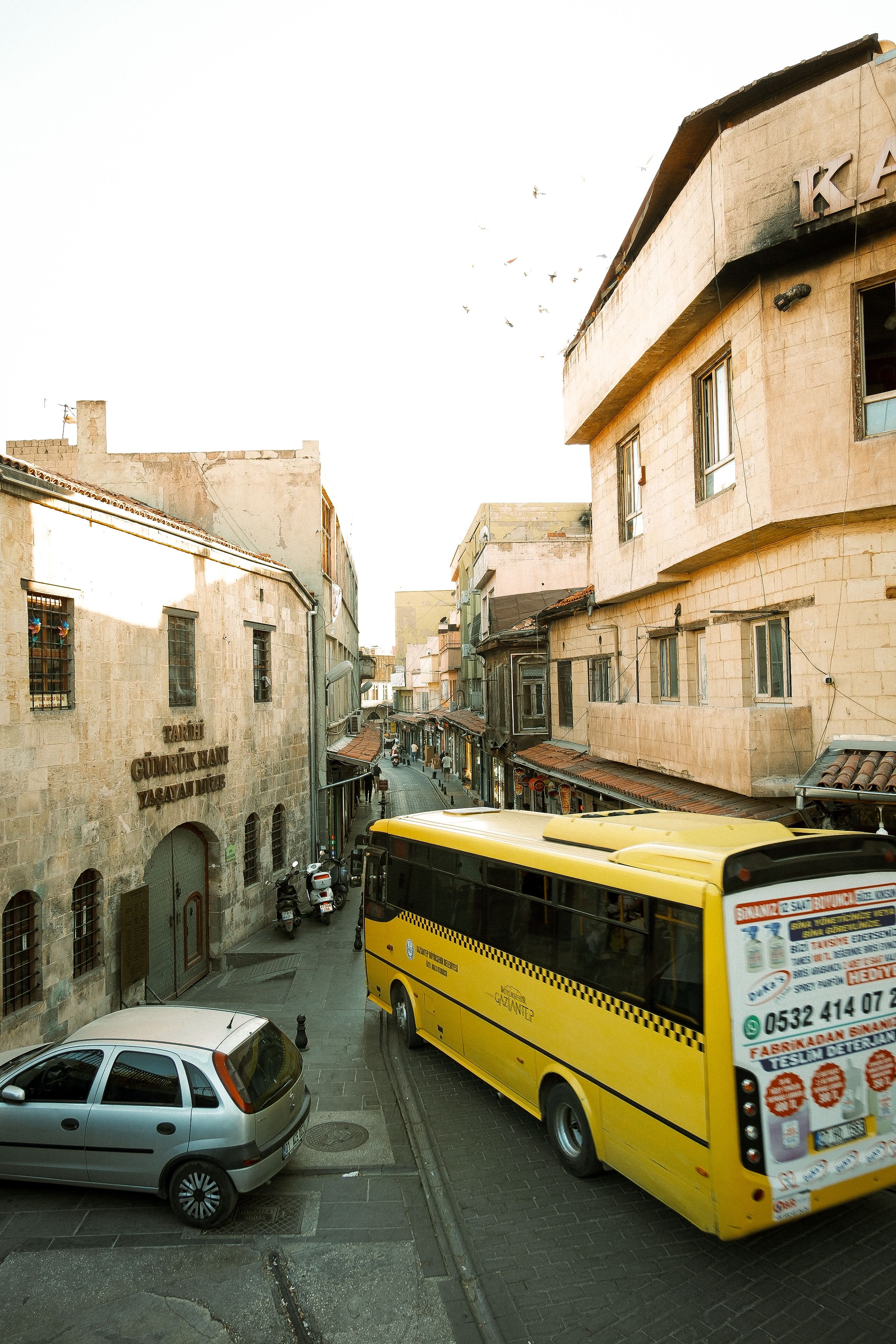 Busy Street Scene with Yellow Bus in Historic City · Free Stock Photo