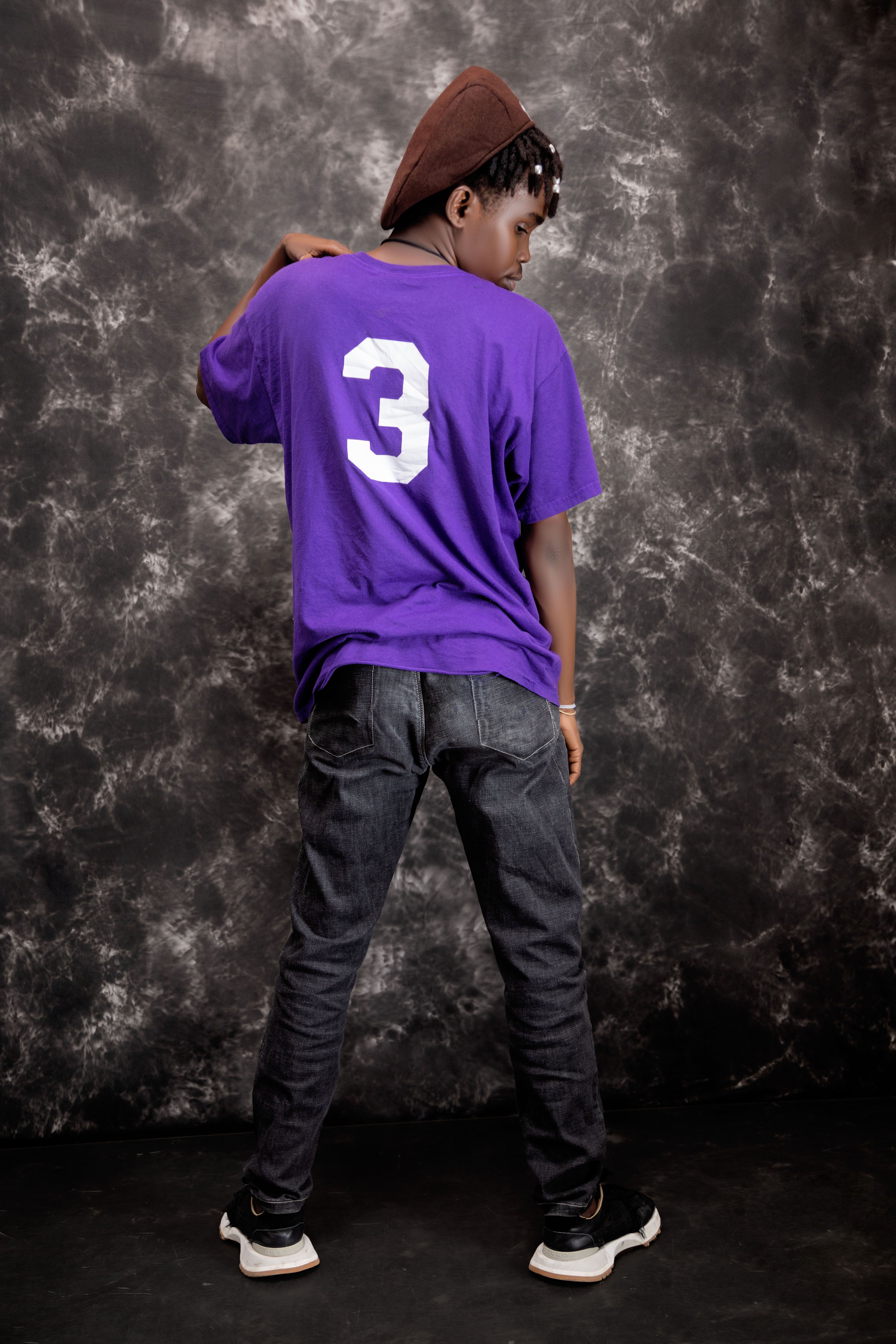 Young Man in Stylish Purple Outfit with Number 3 Shirt · Free Stock Photo