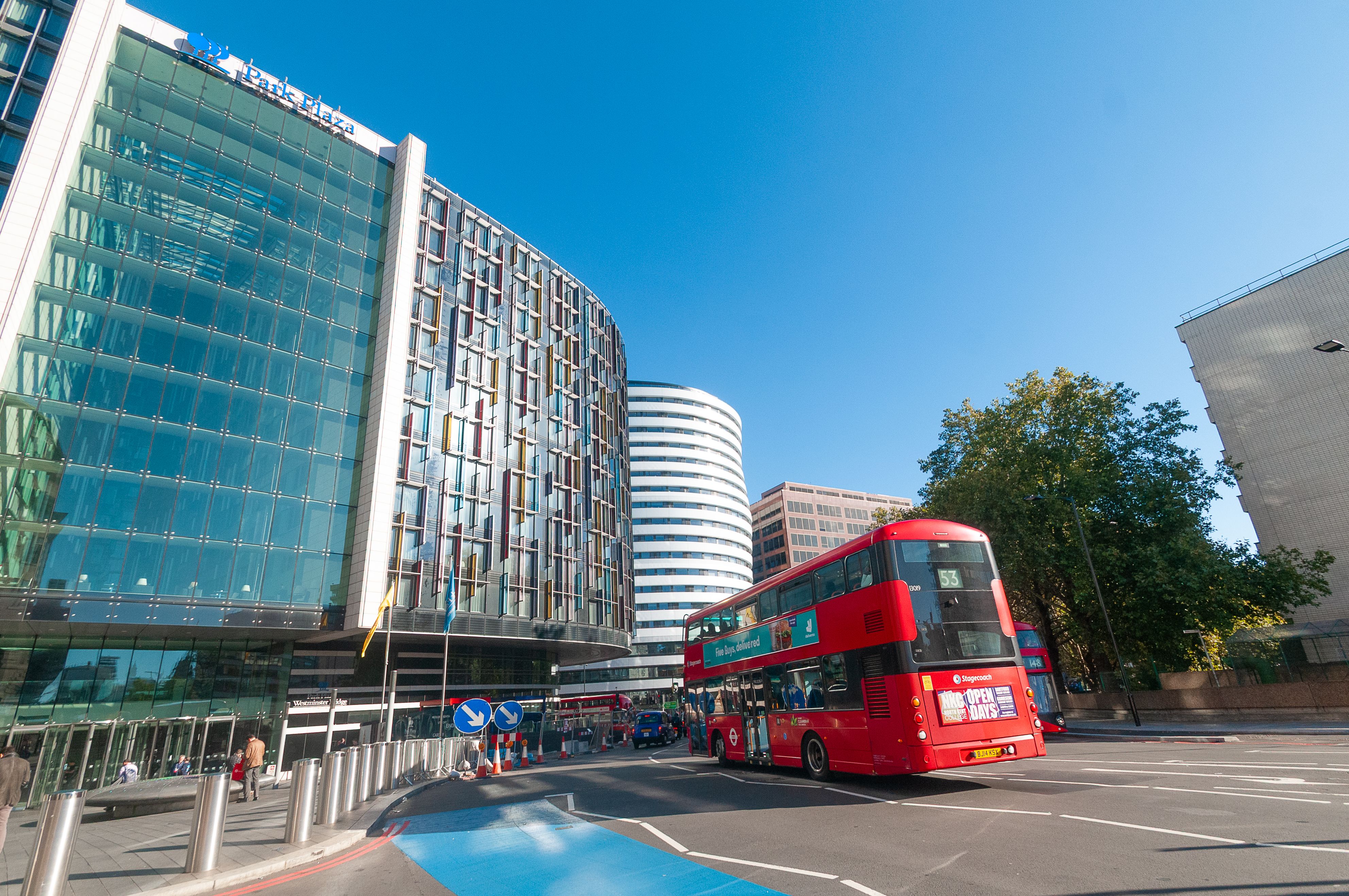 Iconic Red Double-Decker Bus in London Street Scene · Free Stock Photo