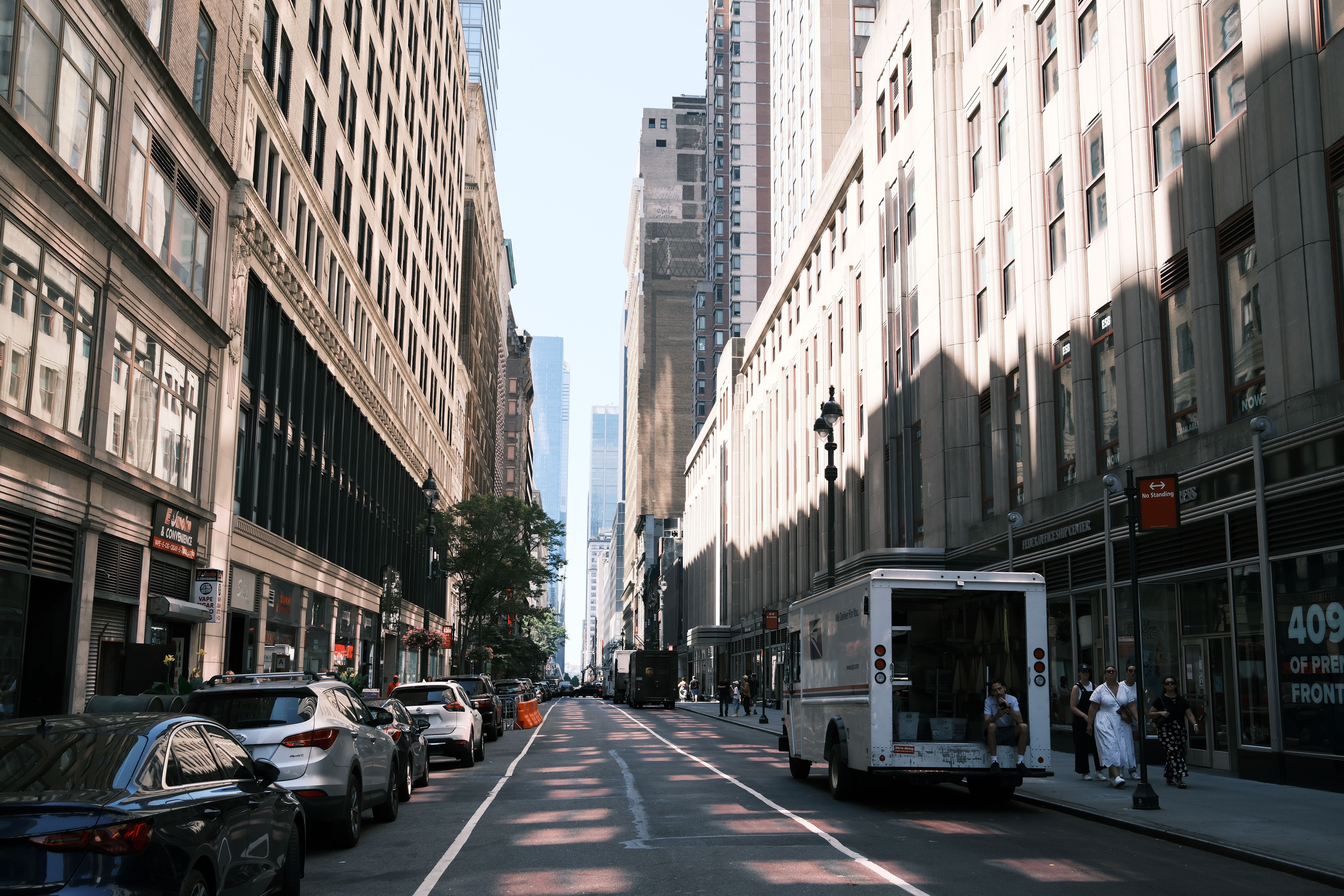 Vehicles on Road Between Buildings · Free Stock Photo