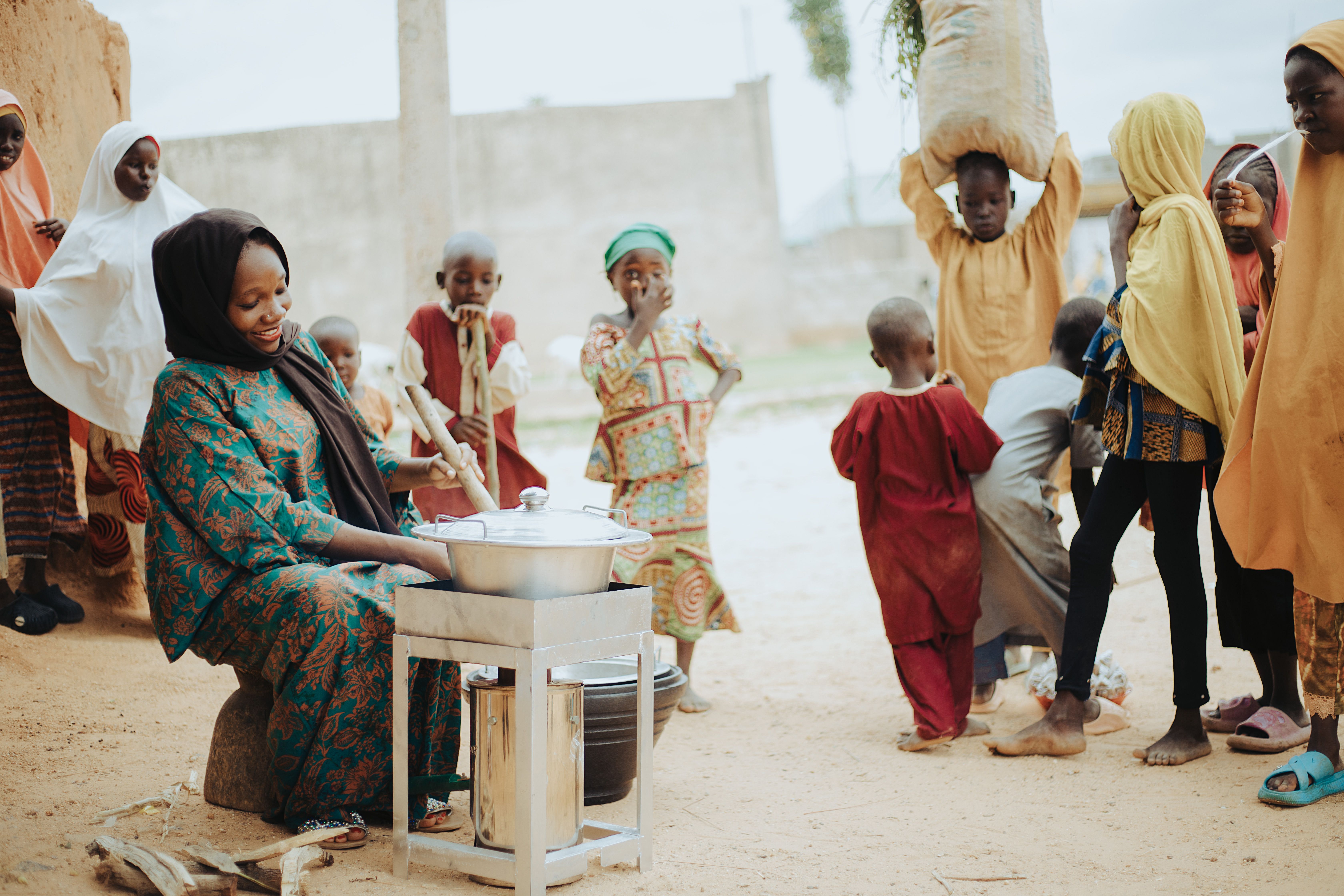 African Community Gathering with Outdoor Cooking · Free Stock Photo