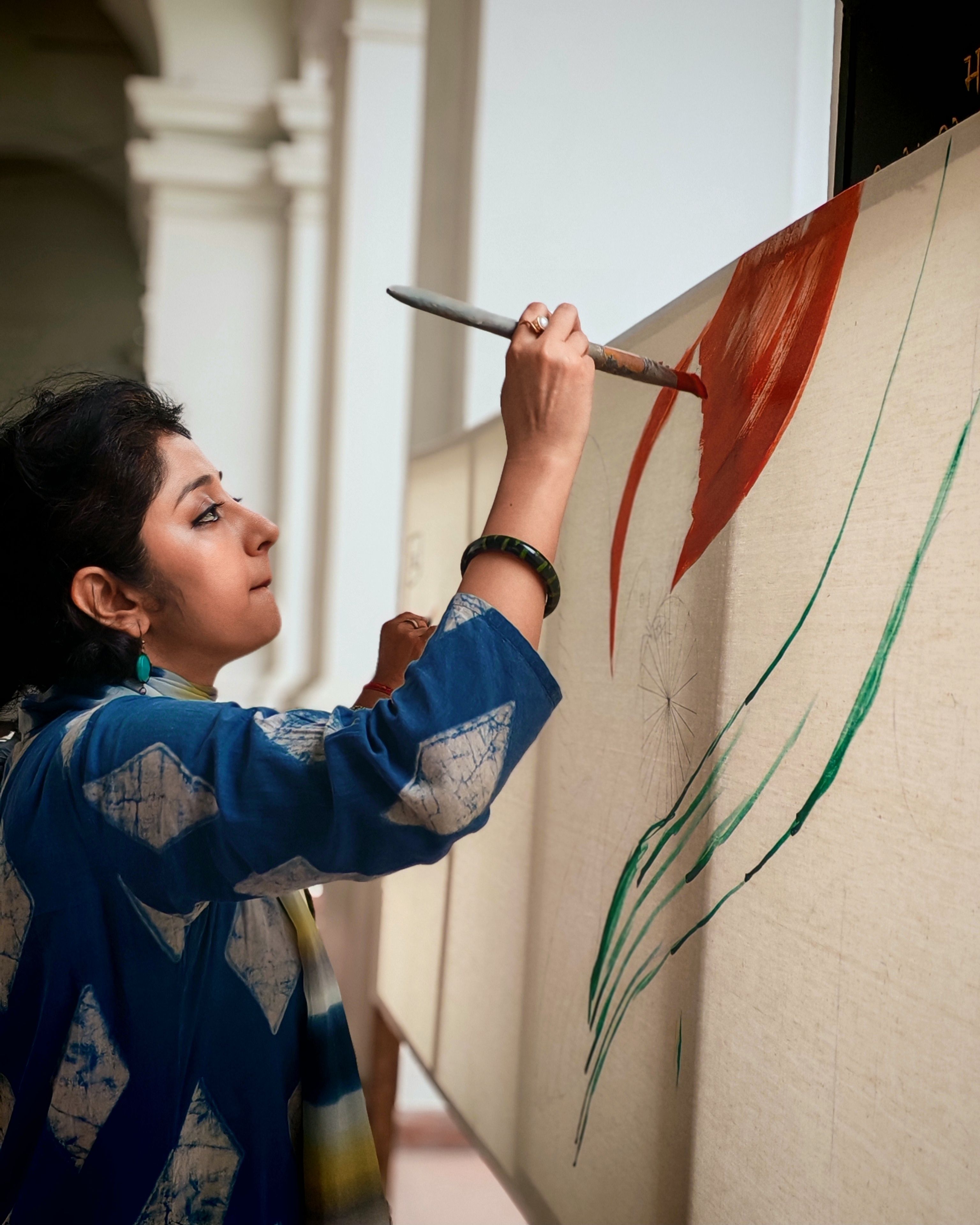 Indian Artist Painting a Mural with Passion · Free Stock Photo