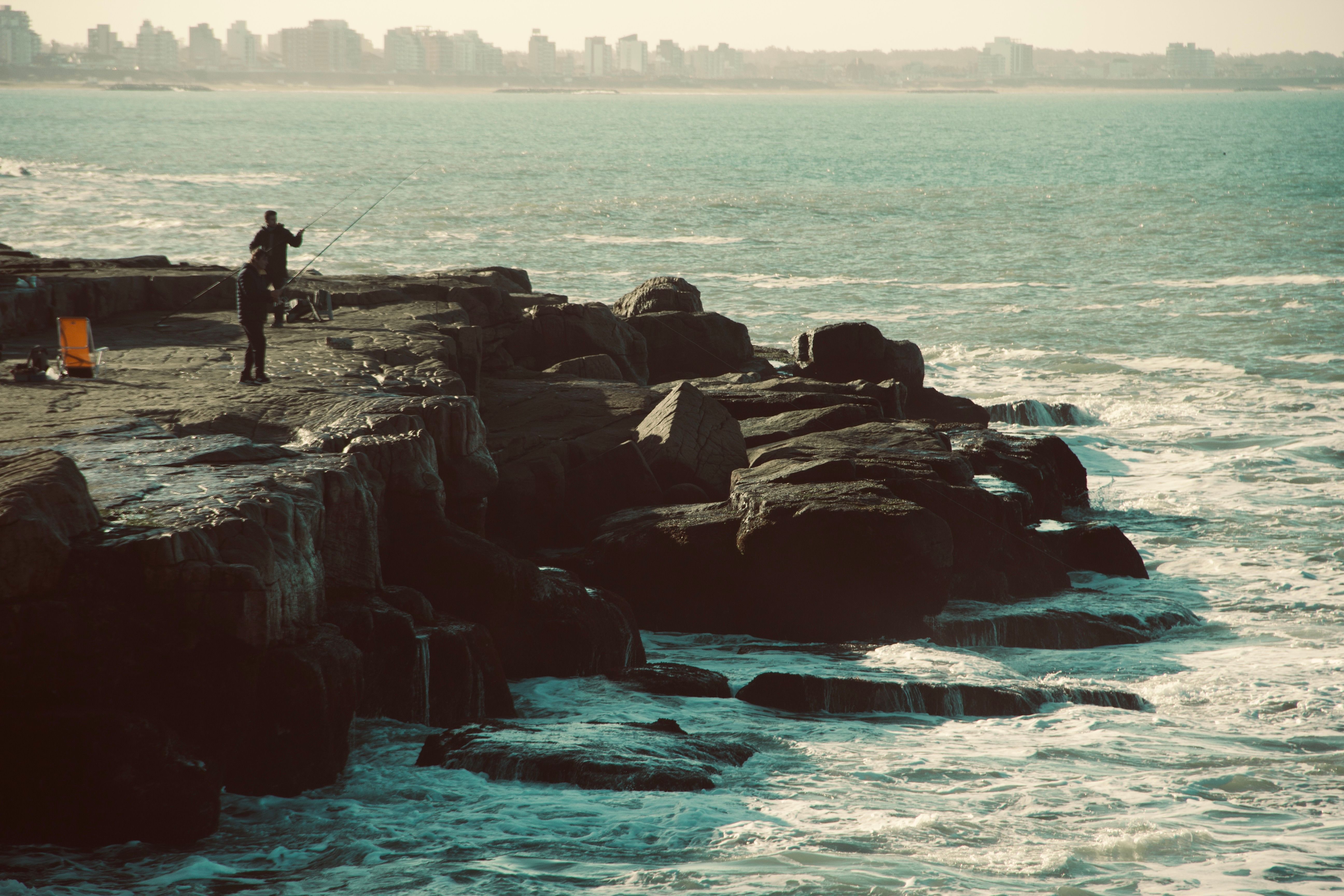 Coastal Fishing on Rocky Shoreline at Dawn · Free Stock Photo