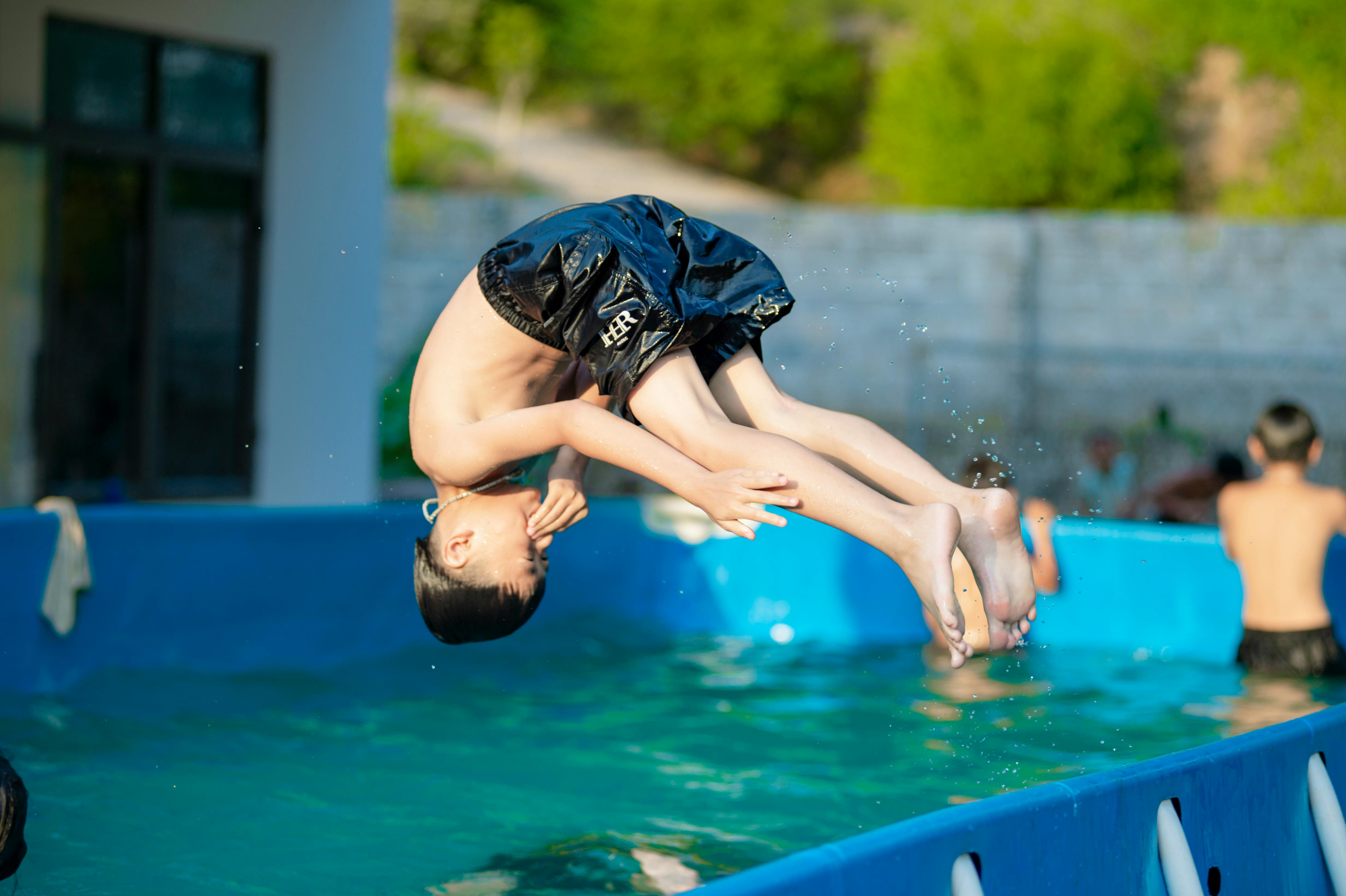 Child Flipping into Swimming Pool in Hanoi · Free Stock Photo