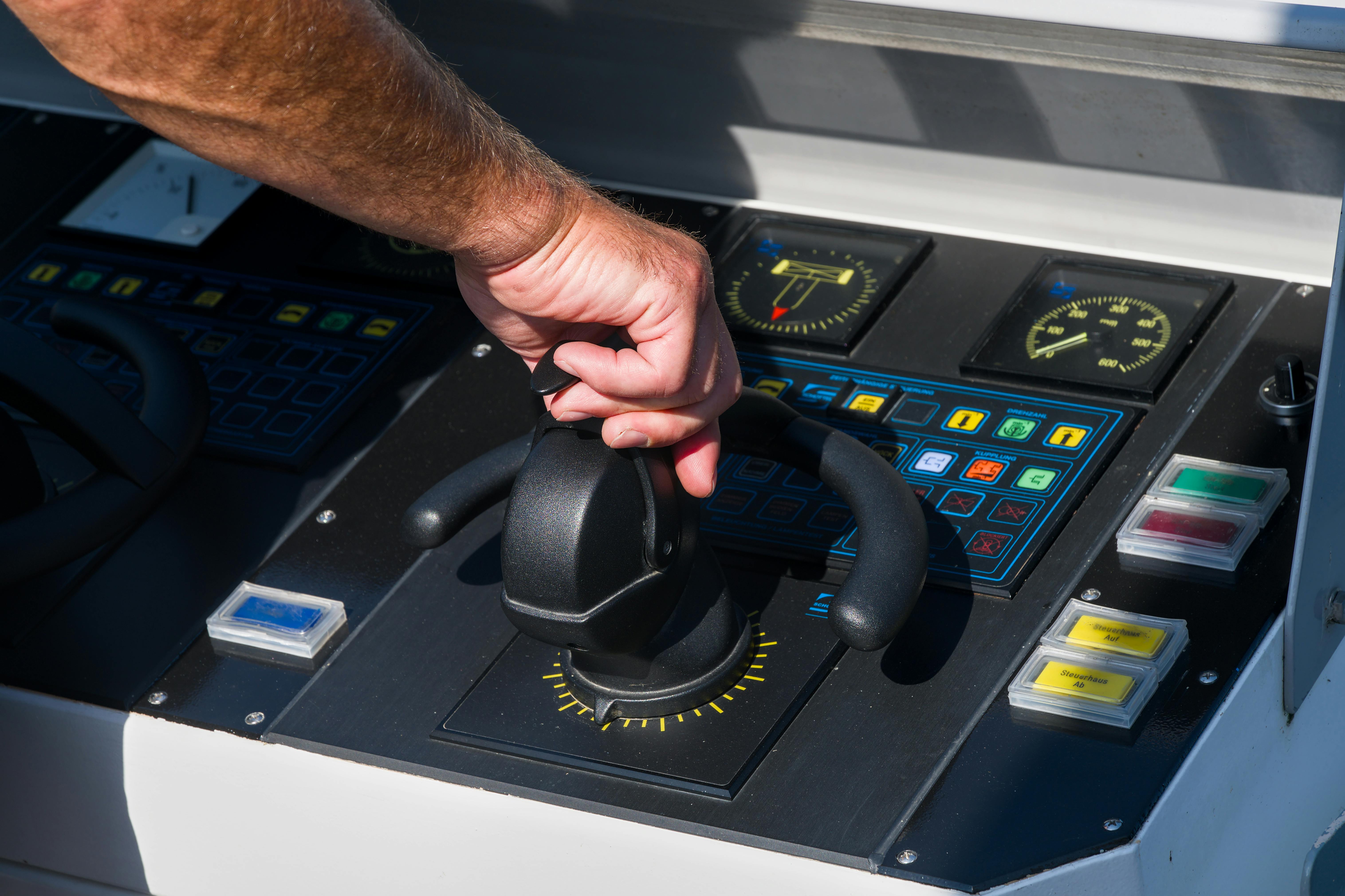Close-up of Hand Operating Boat Control Panel · Free Stock Photo
