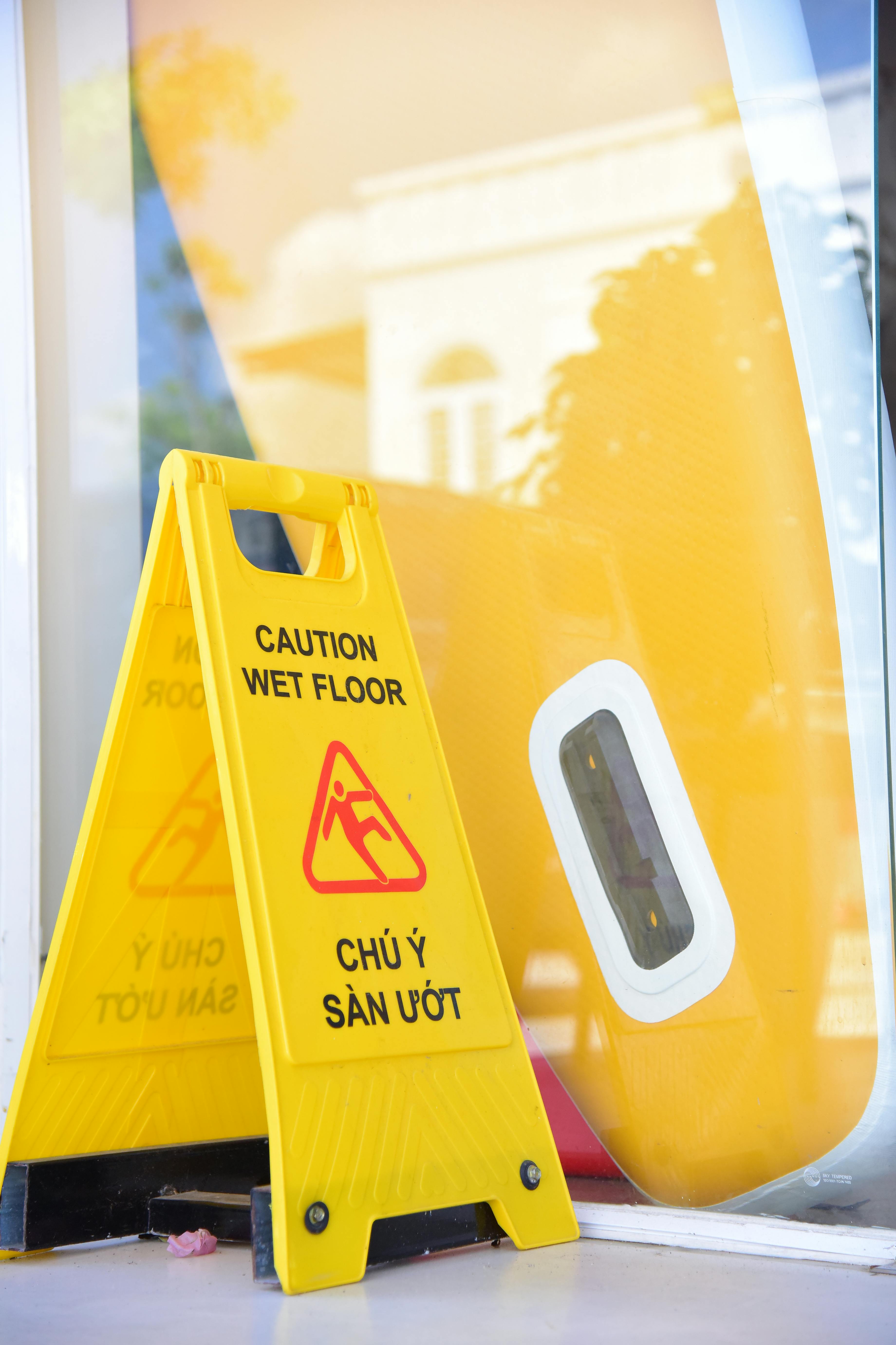 Yellow Caution Wet Floor Sign Indoors · Free Stock Photo