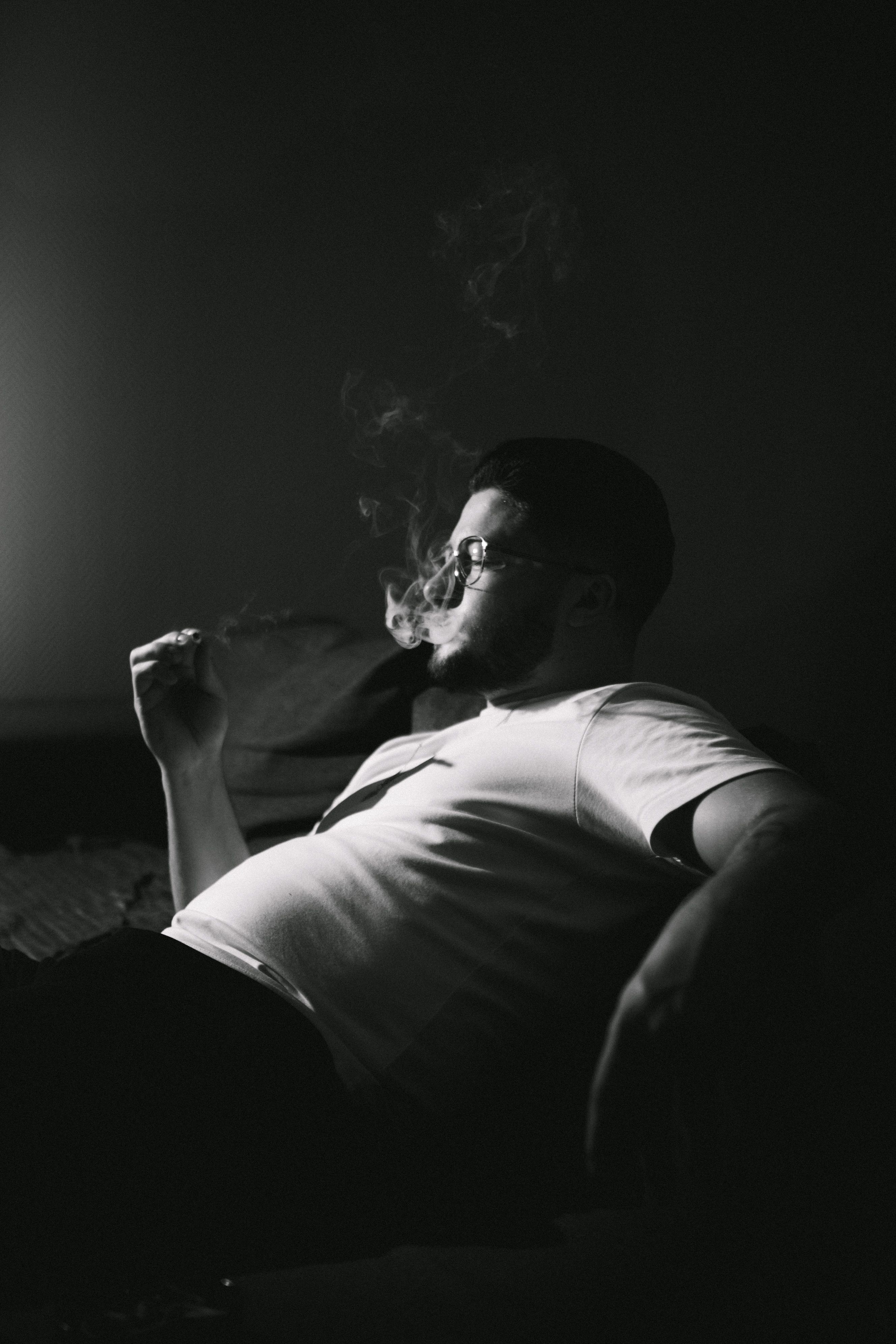 Man Leaning on the Wall while Smoking · Free Stock Photo