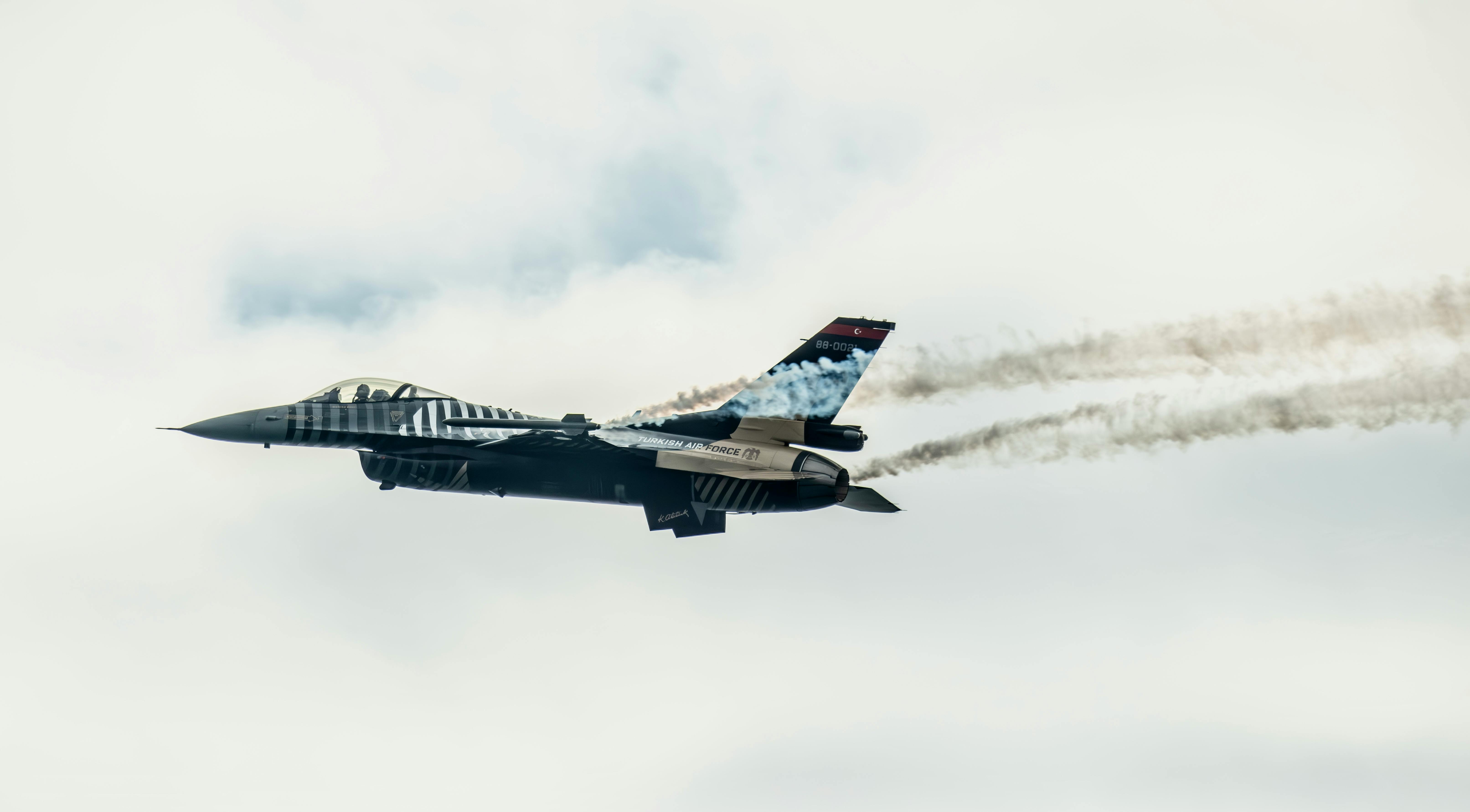High-Speed Military Jet Soaring Through Cloudy Sky · Free Stock Photo