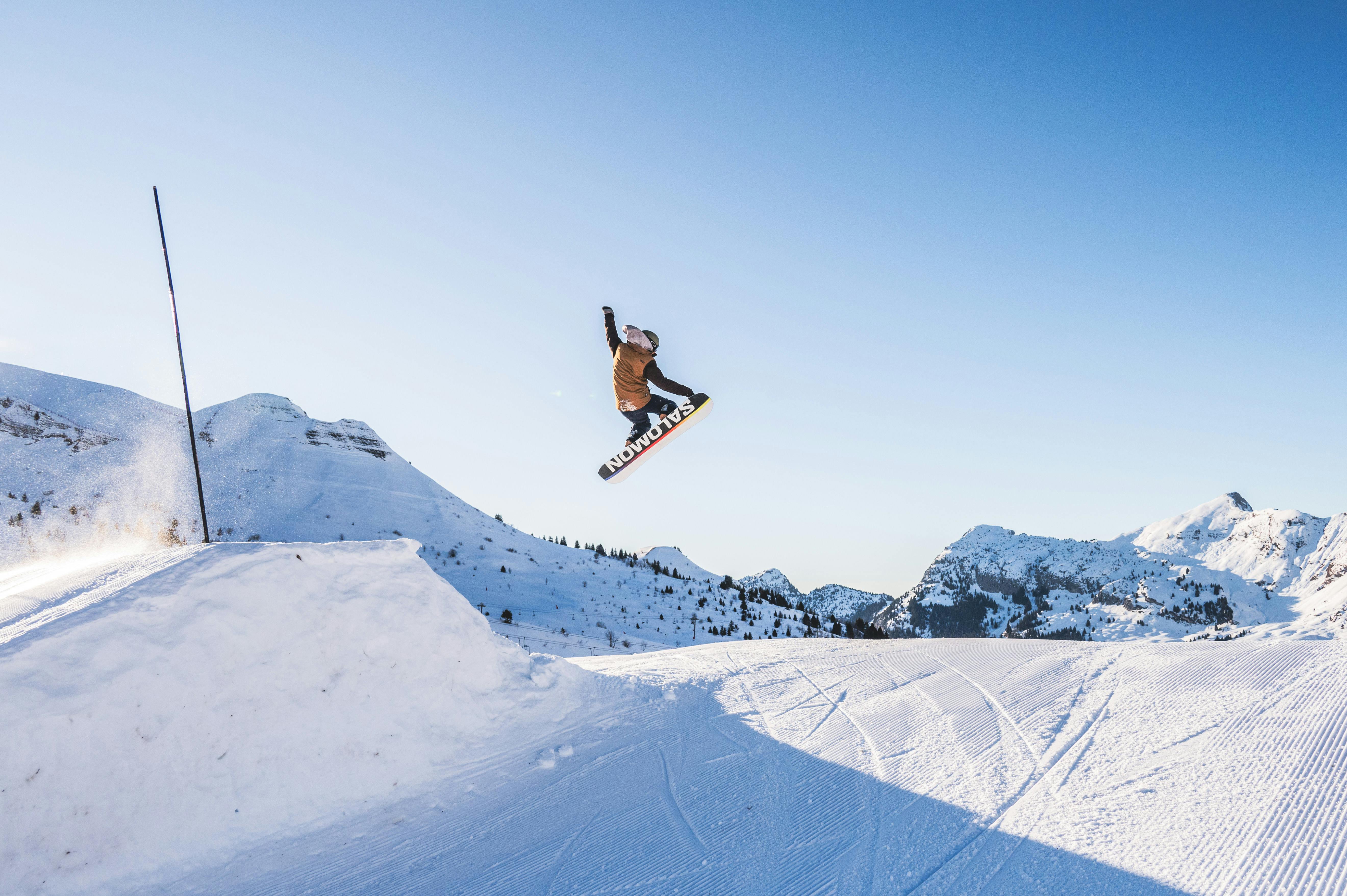 Man in Black Snowboard With Binding Performs a Jump · Free Stock Photo