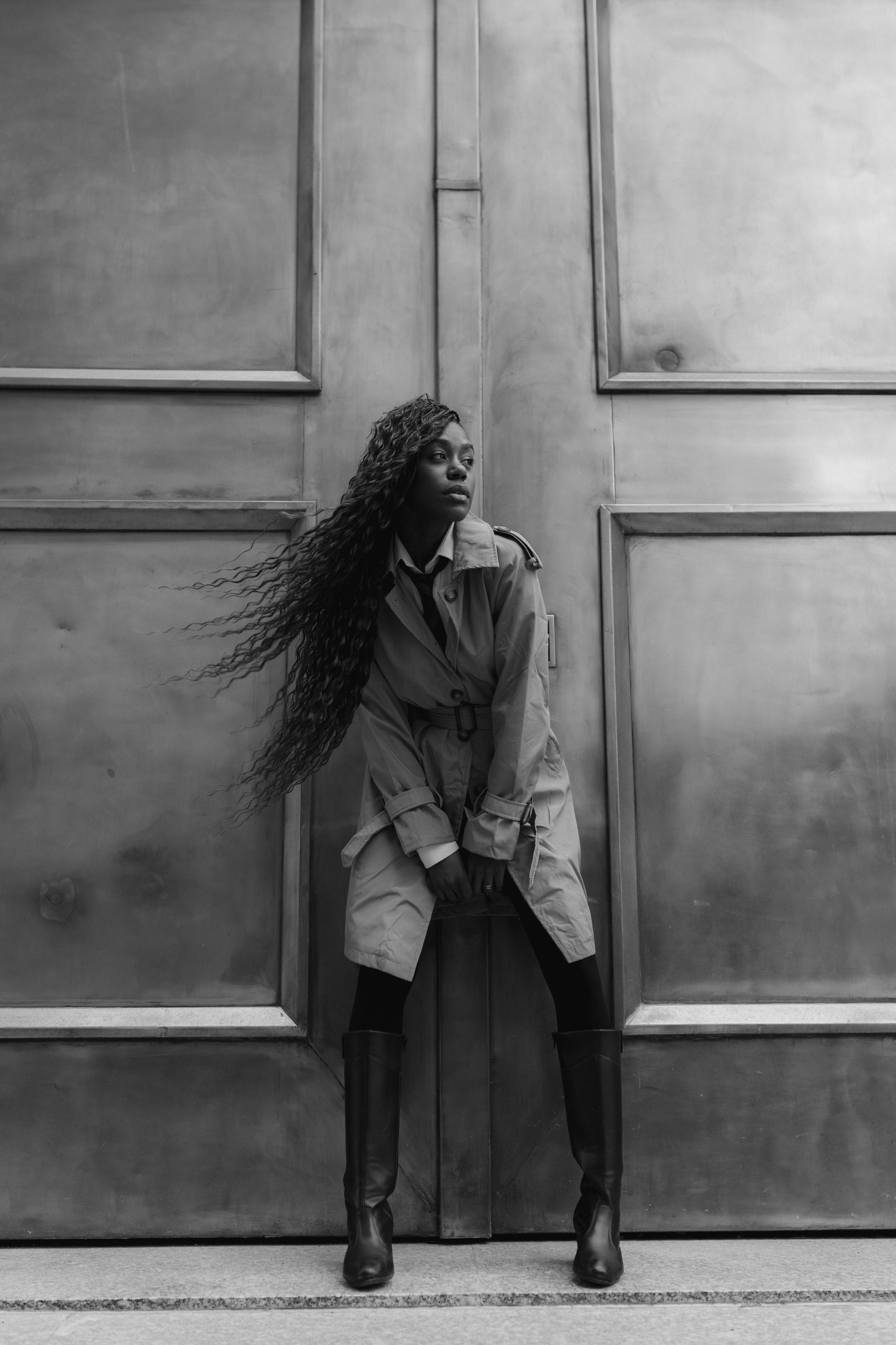 Fashionable Woman Posing by Large Metal Doors · Free Stock Photo