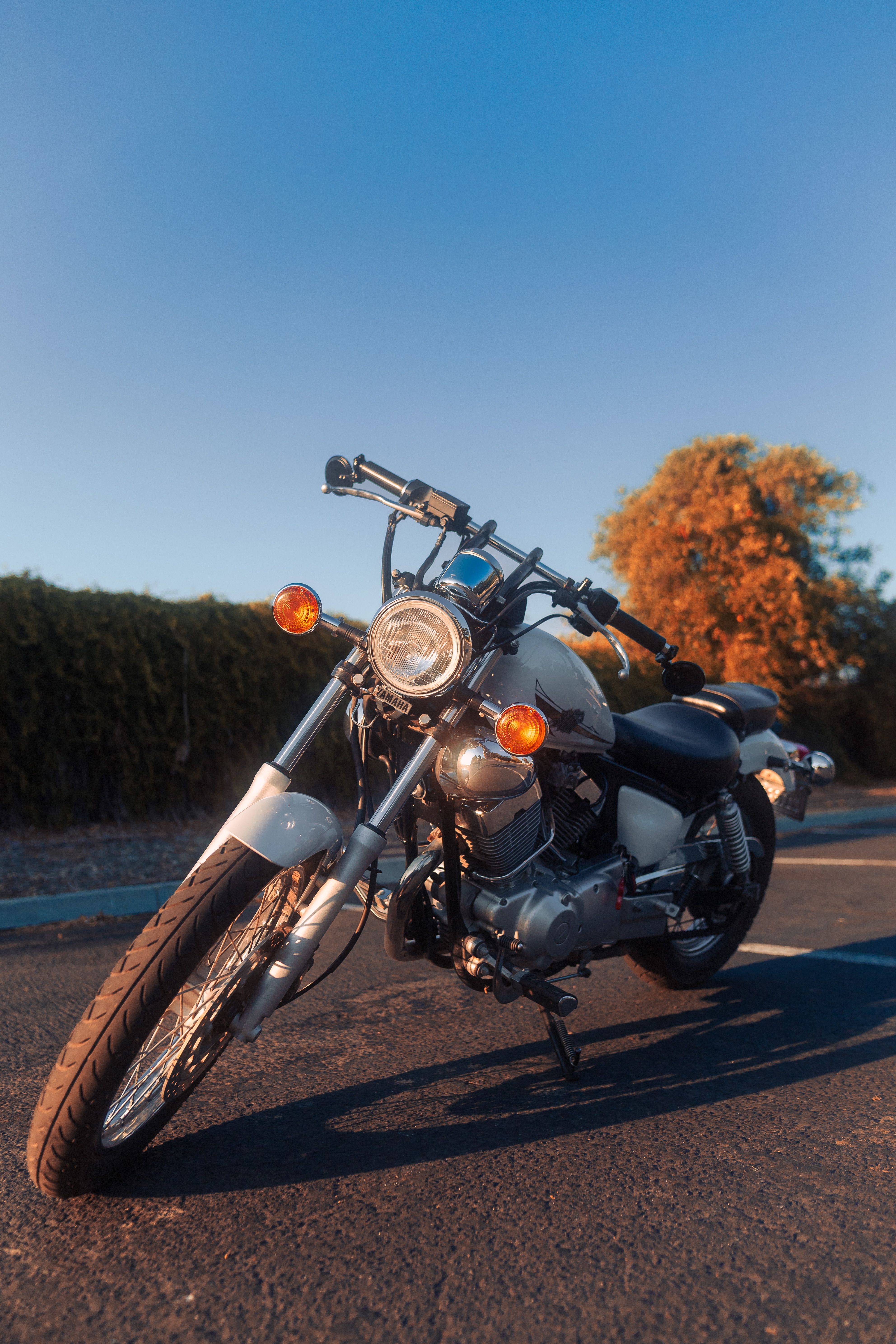 Classic White Motorcycle on Open Road at Sunset · Free Stock Photo