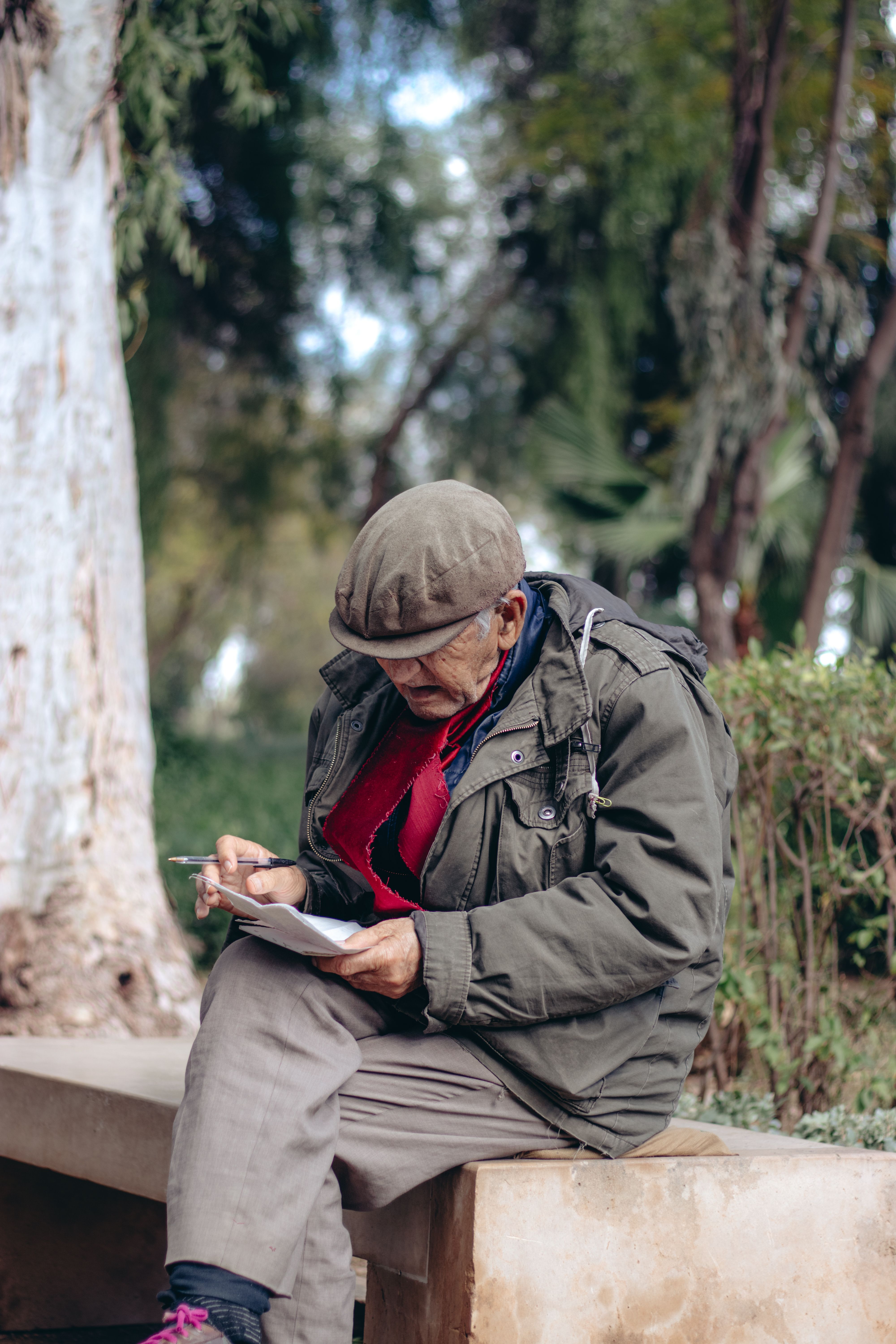 Elderly Man Writing in Park on Winter Day · Free Stock Photo