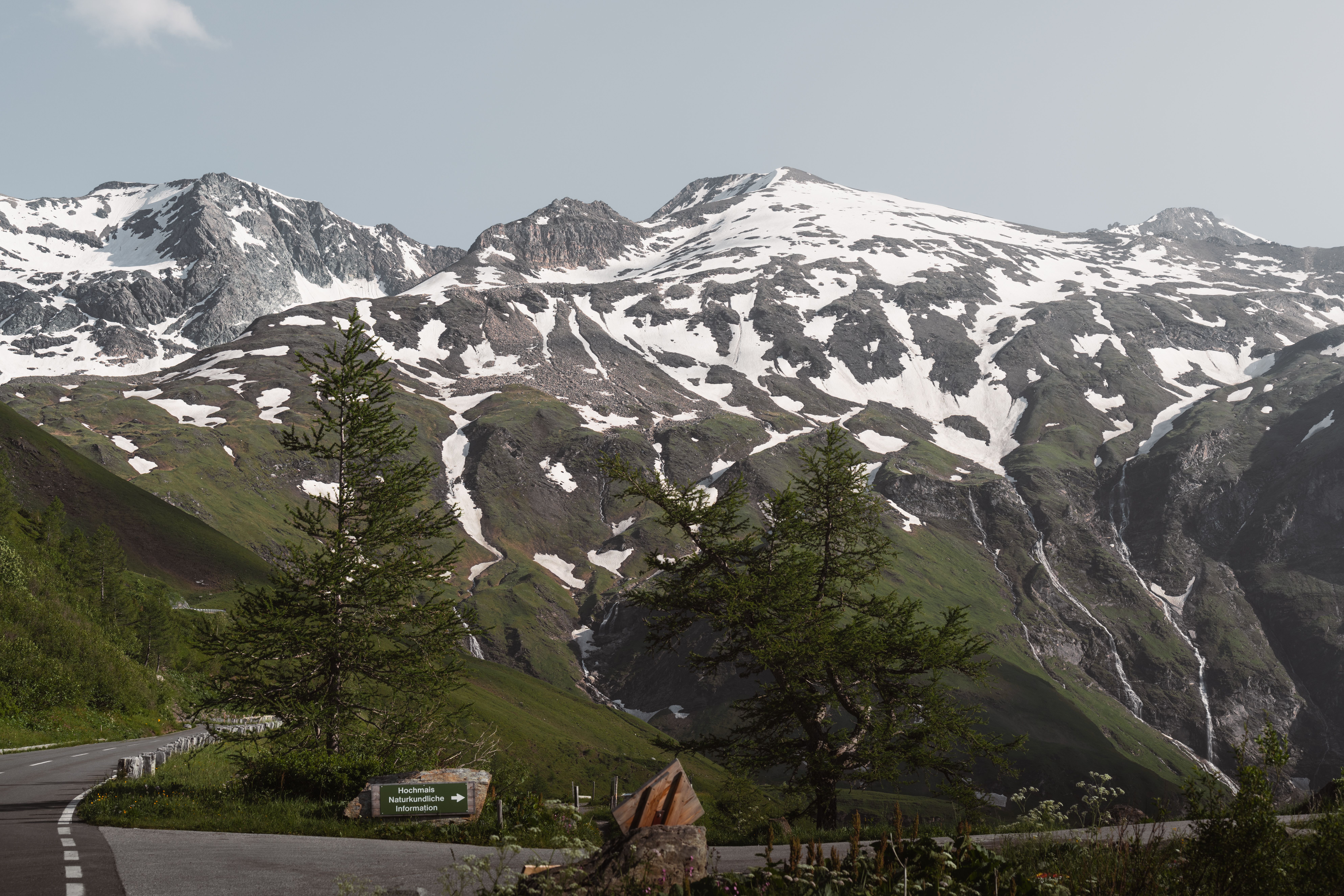 Scenic Alpine Road with Snowy Mountains in Summer · Free Stock Photo