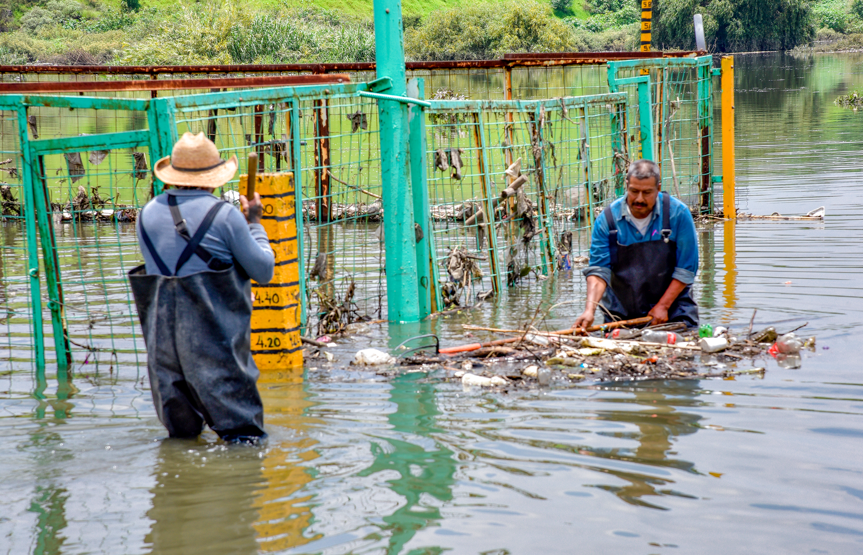 Men Clearing Debris in Flooded Urban Area · Free Stock Photo