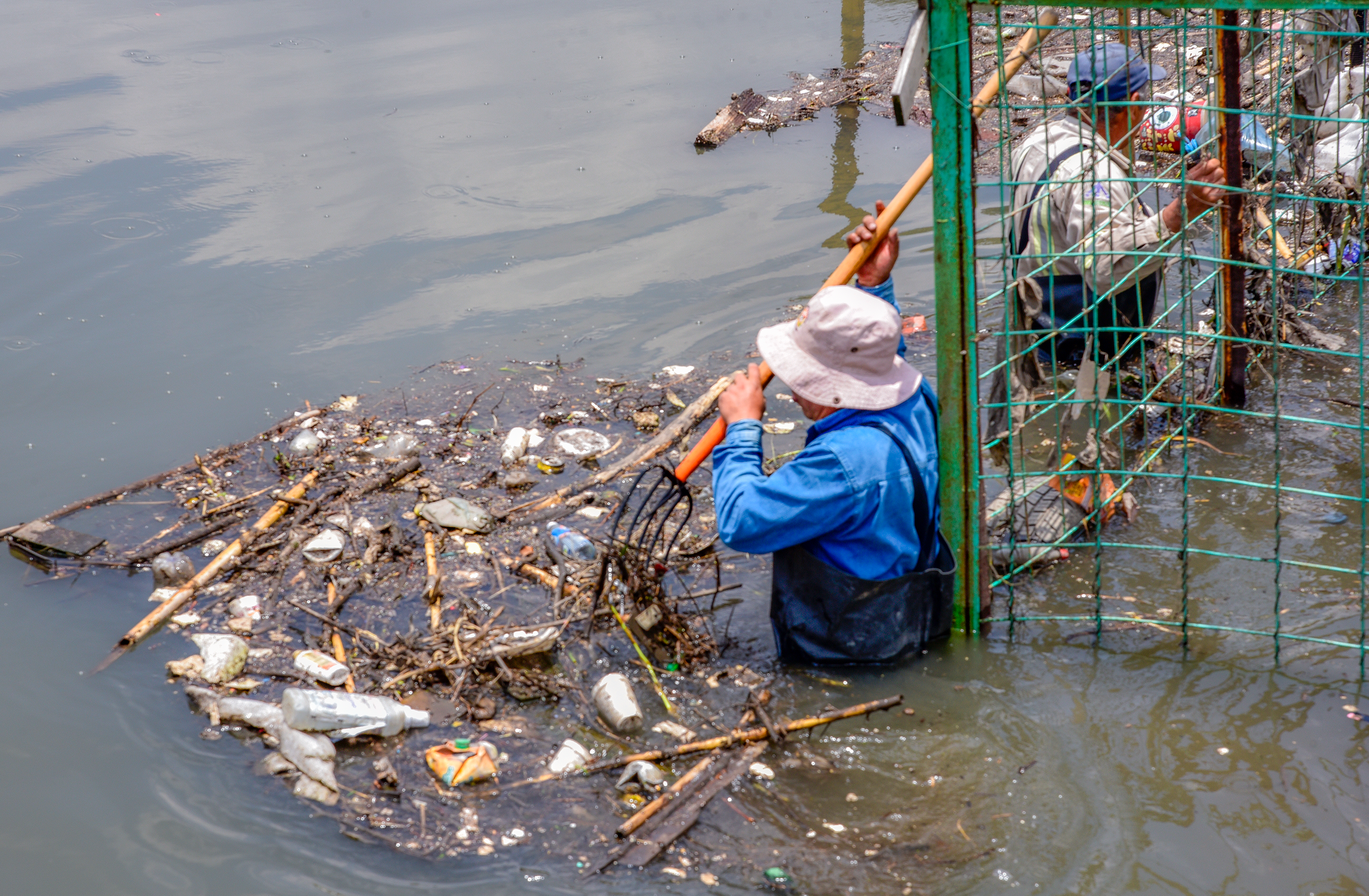 Men Clearing Debris in Flooded Urban Area · Free Stock Photo