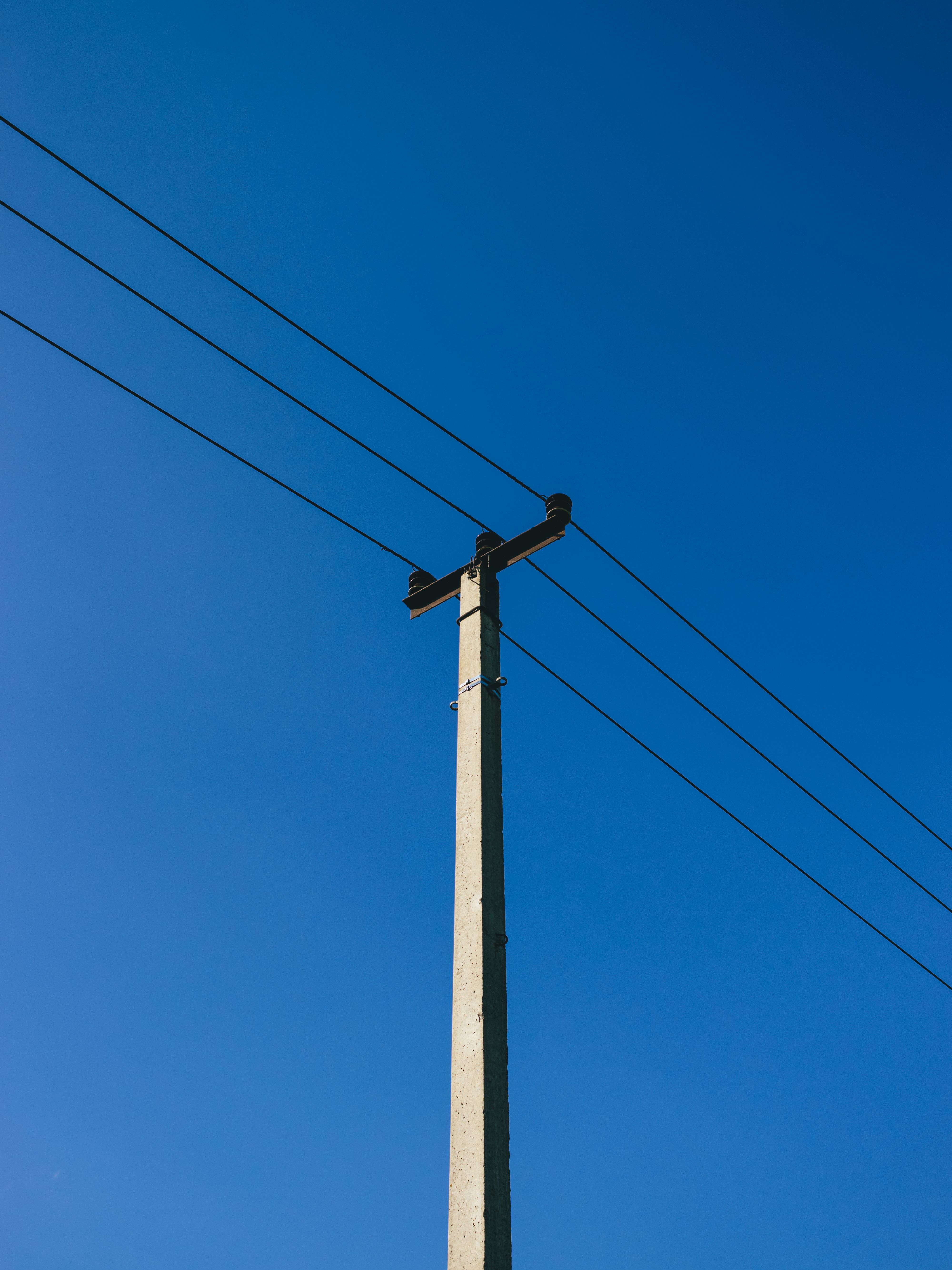 Utility Pole Against Clear Blue Sky · Free Stock Photo