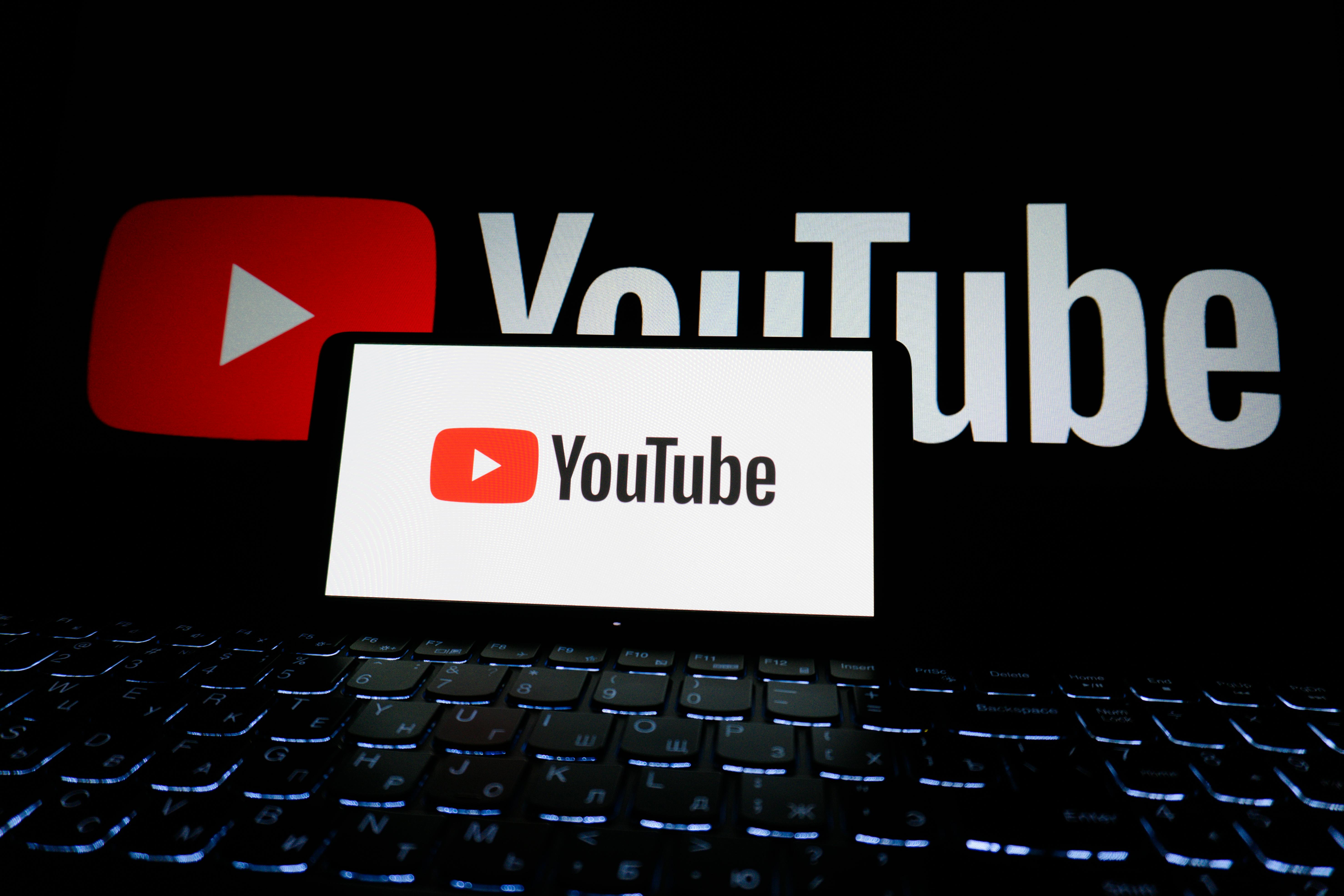 YouTube Logo on Laptop Screen in Dark Setting · Free Stock Photo