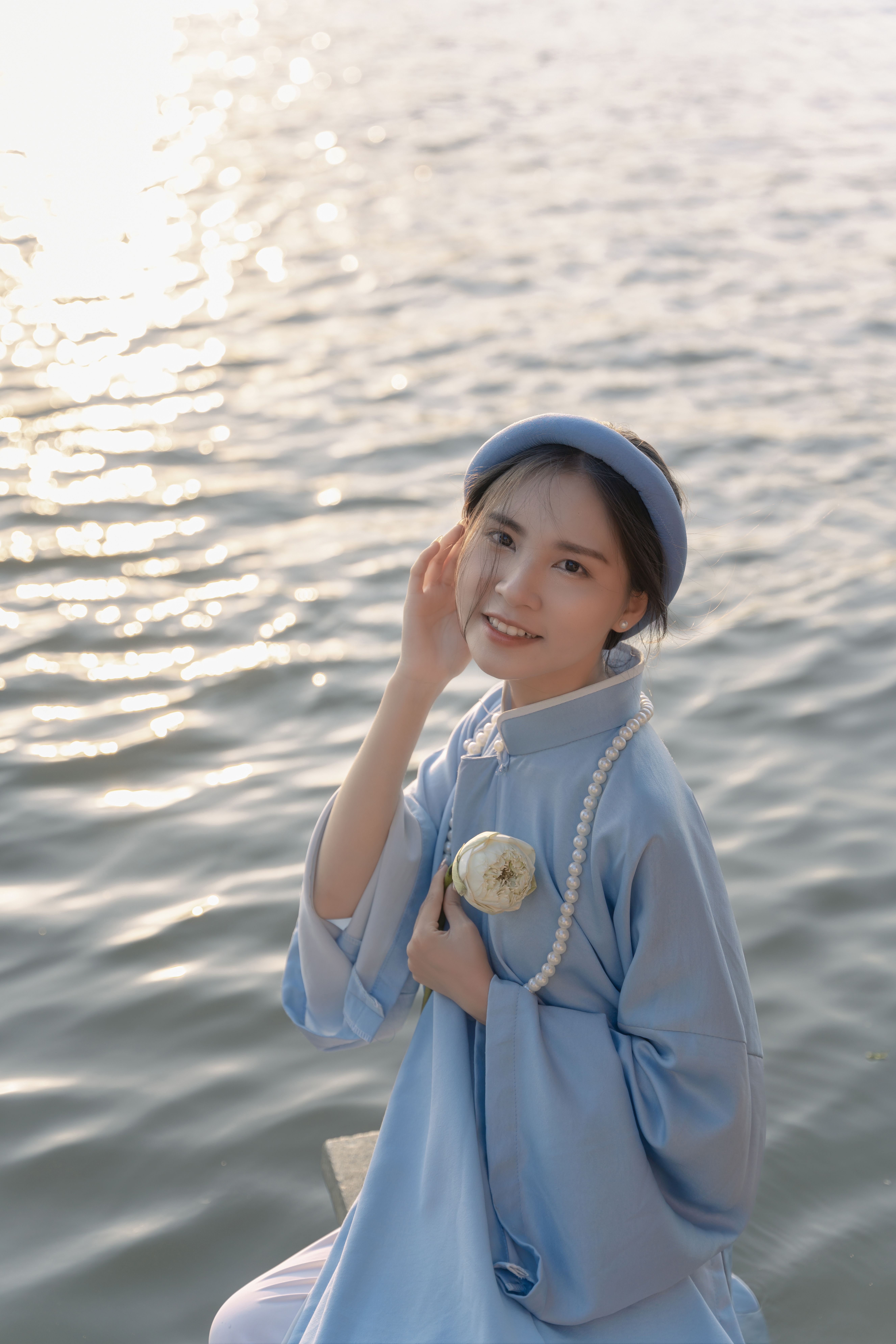 Young Woman in Blue Traditional Dress by Waterside · Free Stock Photo
