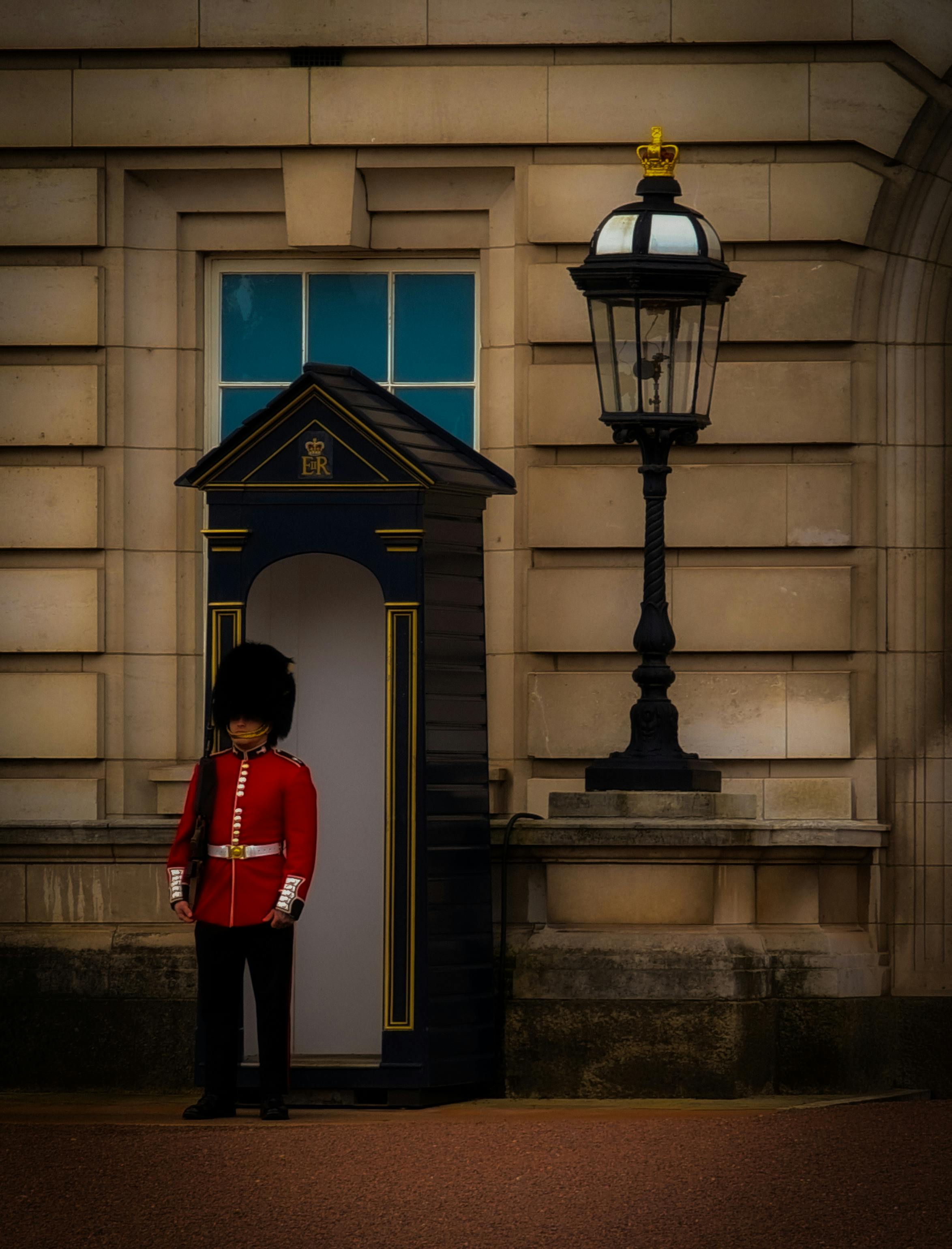 Royal Guard Standing Near Lamp Post · Free Stock Photo