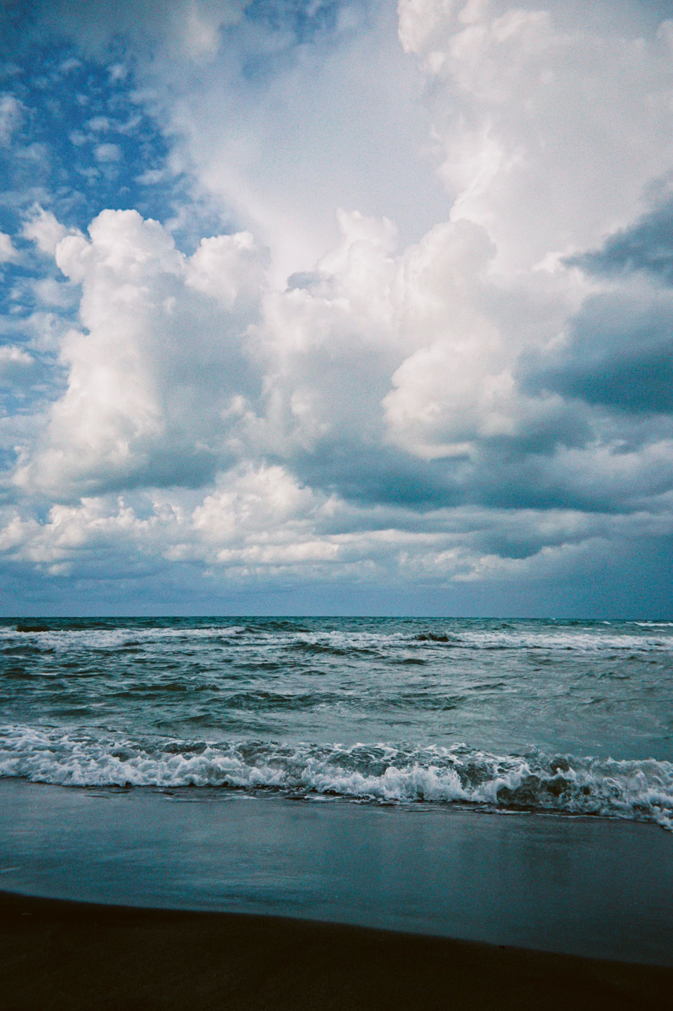 Dramatic Beach Scene with Stormy Clouds · Free Stock Photo