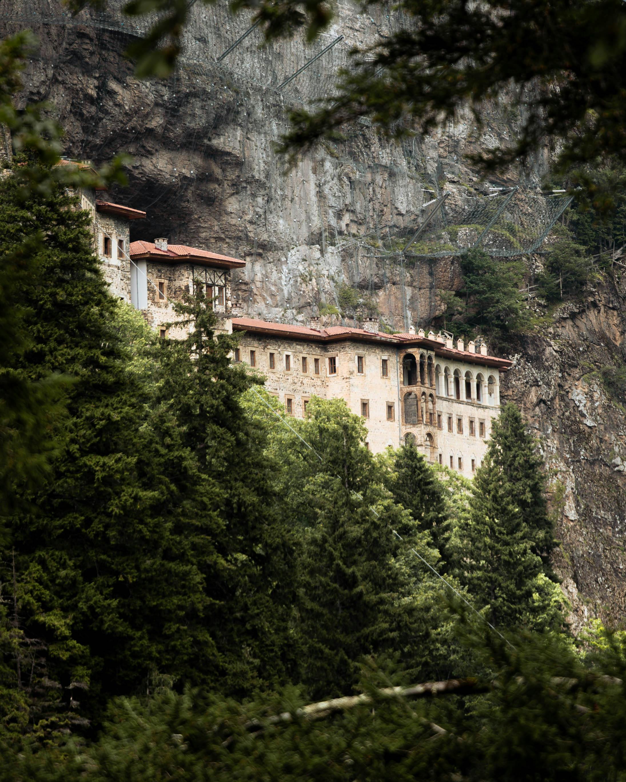 Majestic Cliffside Monastery in Dense Forest · Free Stock Photo