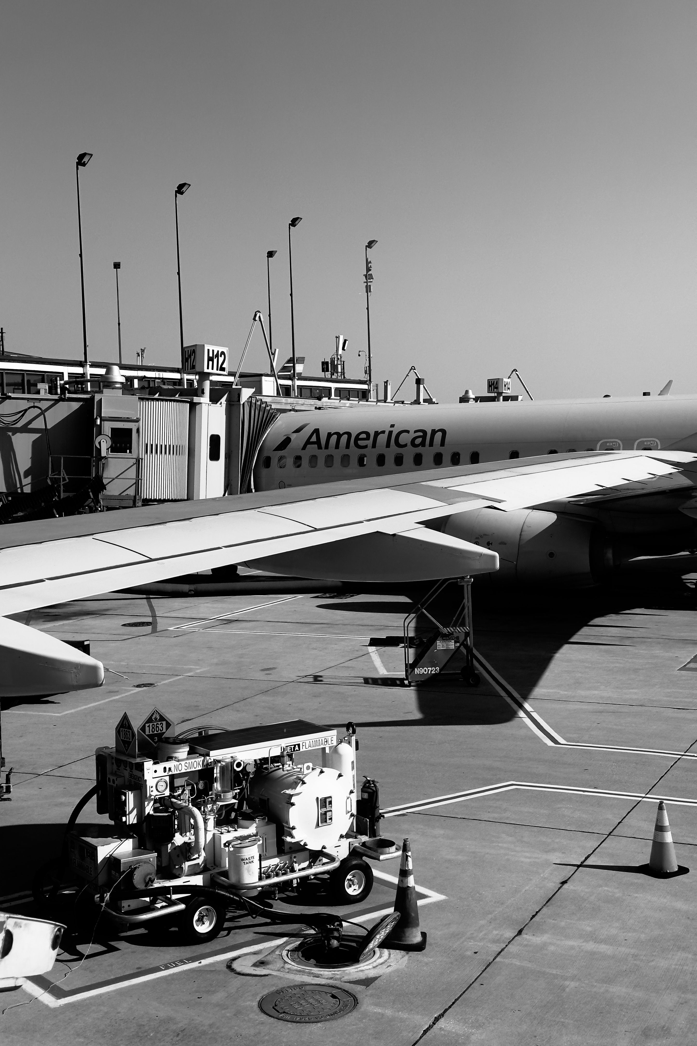 Gray Scale of Air Plane on Runway Under Cloudy Day · Free Stock Photo