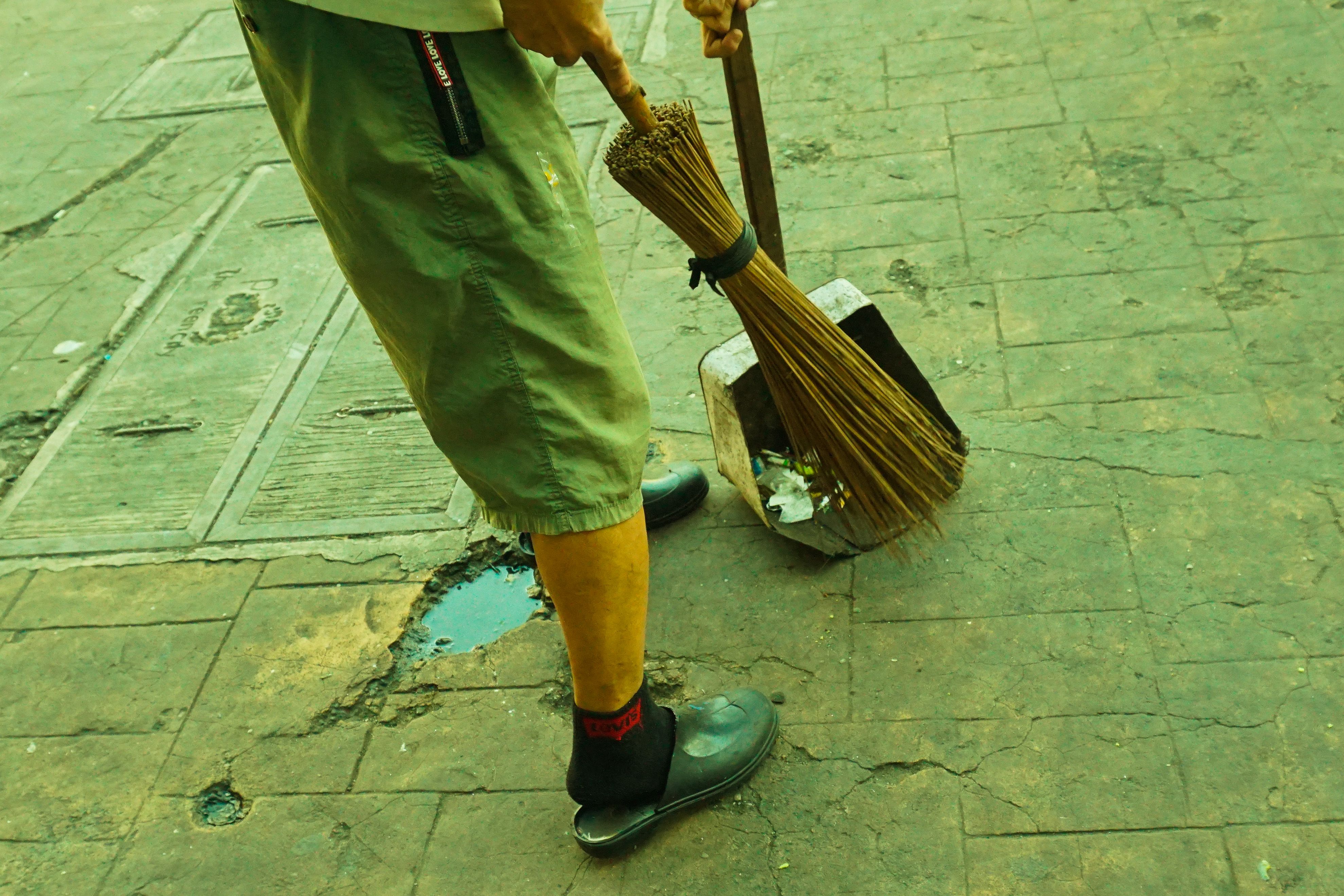 Street Cleaner with Broom on Urban Sidewalk · Free Stock Photo