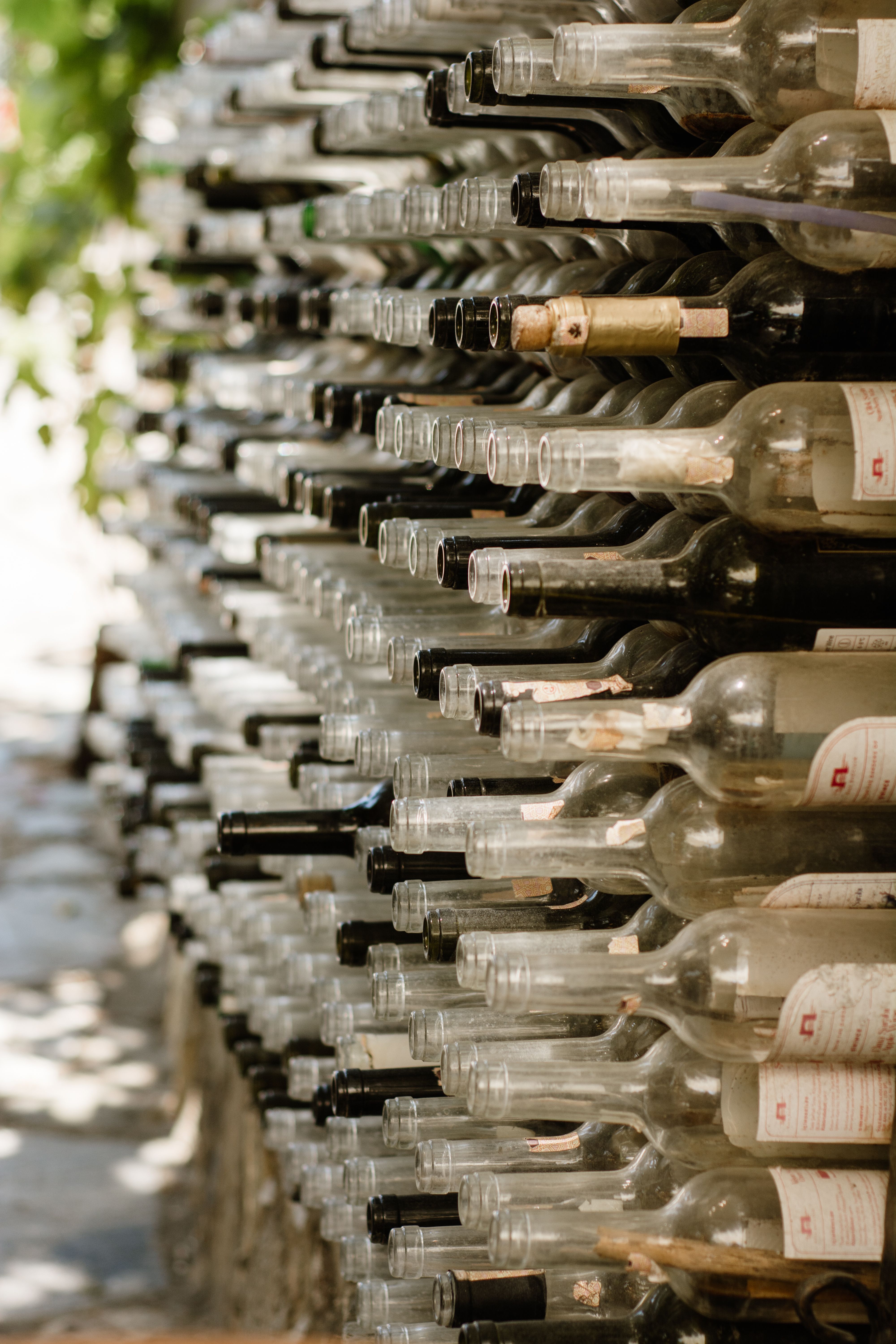 Stacked Wine Bottles Outdoors in Daylight · Free Stock Photo