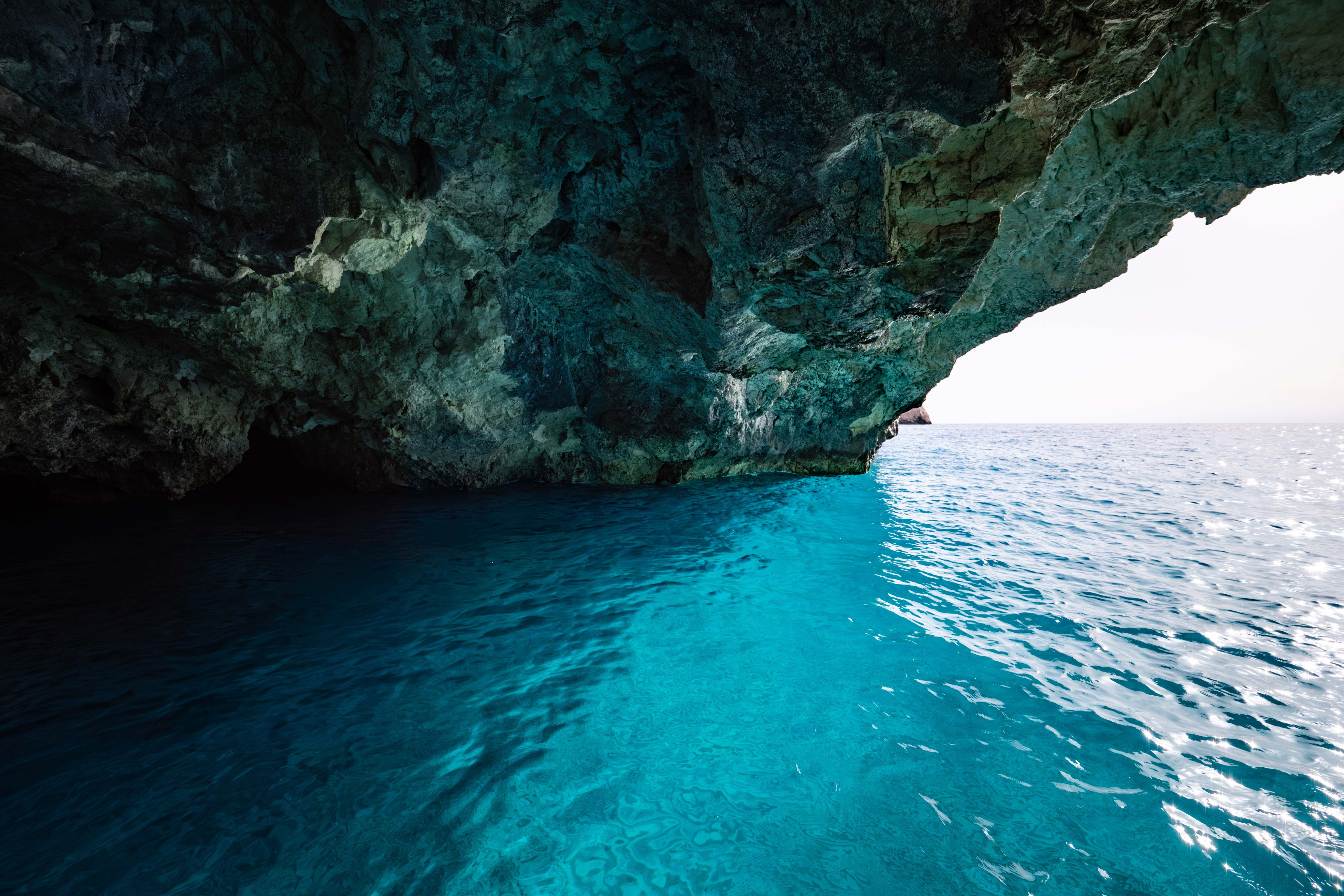 Azure Sea and Coastal Cave in Sunlight · Free Stock Photo