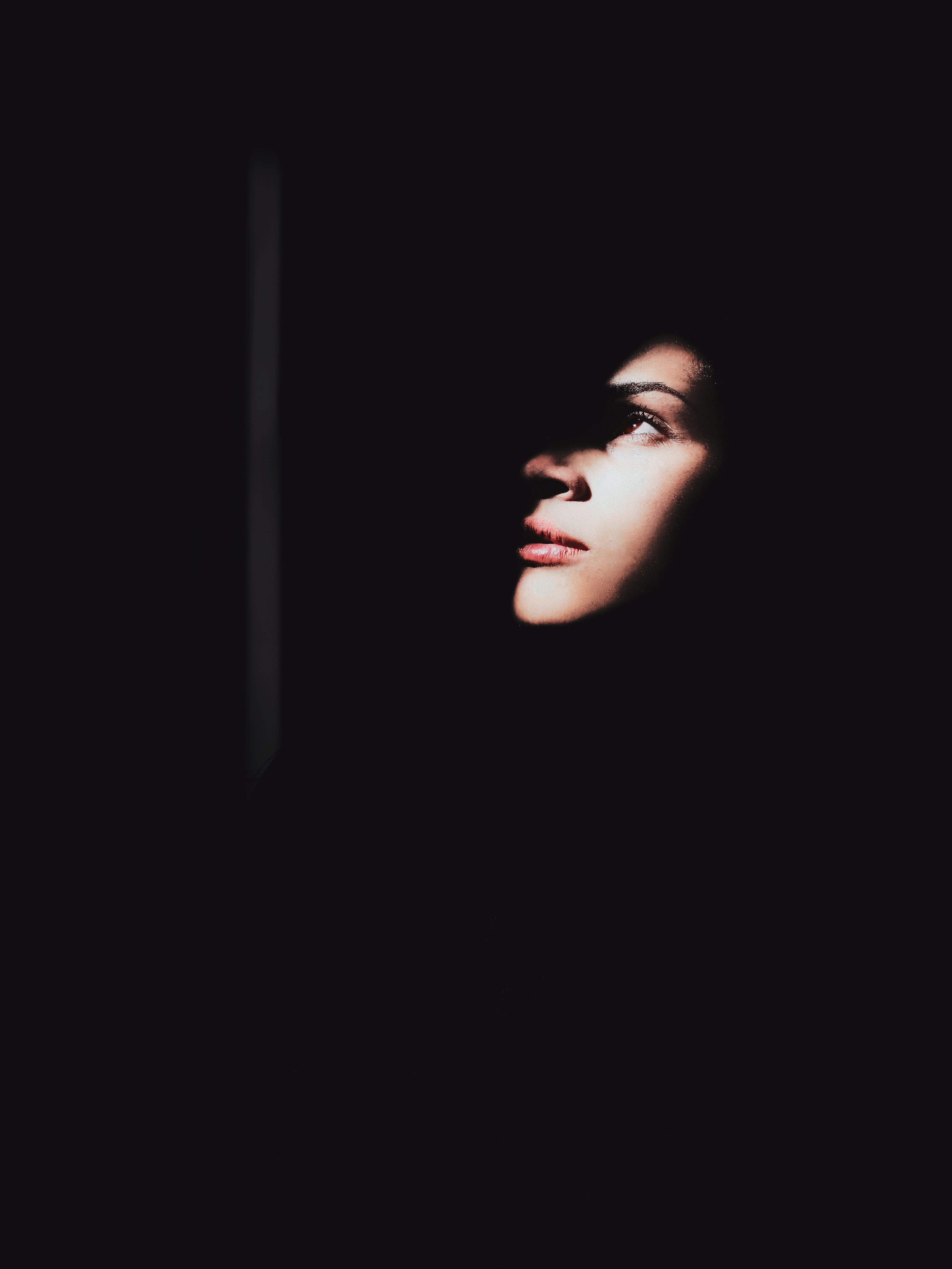 Dramatic Portrait of a Woman in Shadow · Free Stock Photo