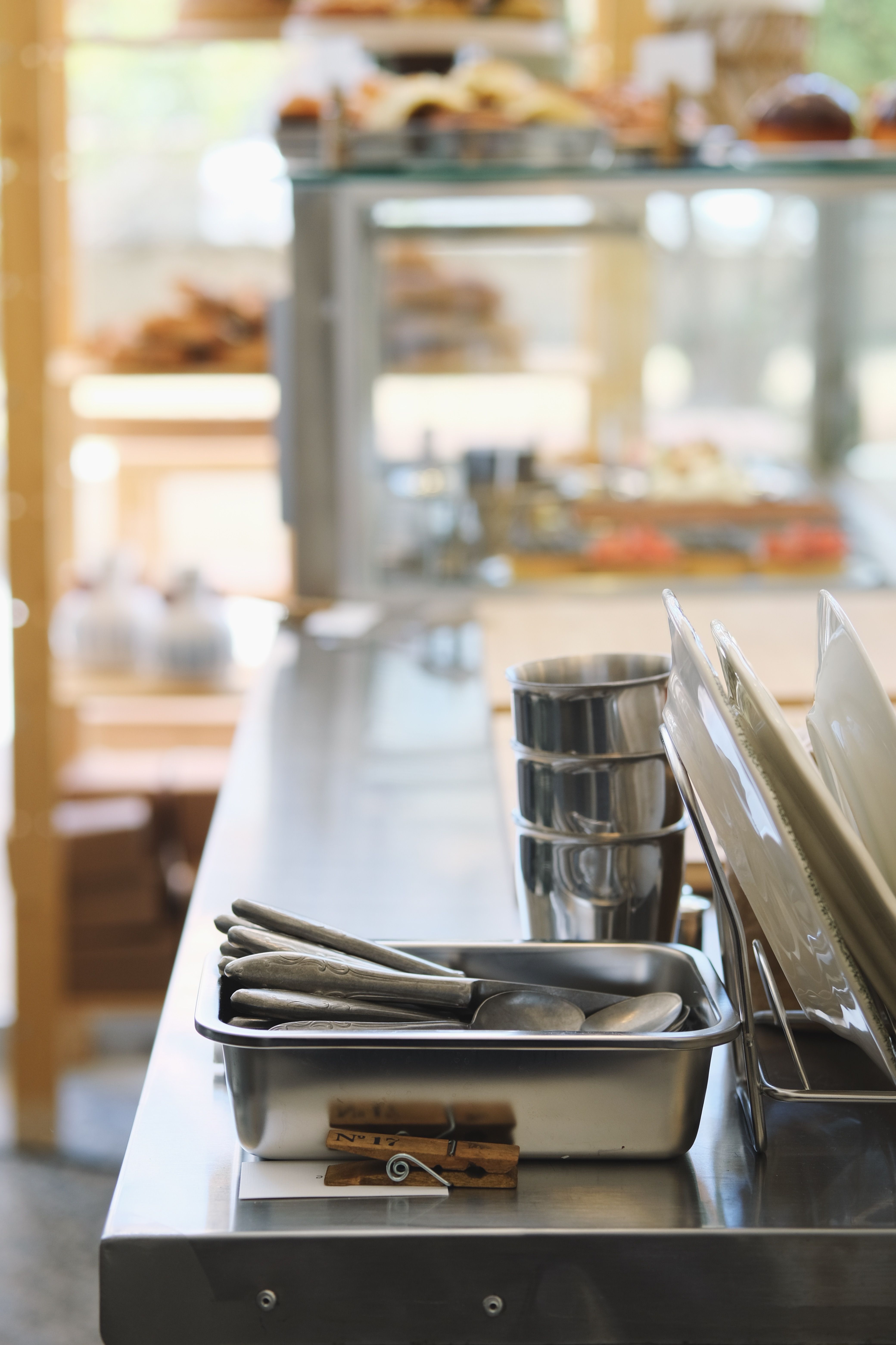 Modern Cafe Interior with Utensils on Counter · Free Stock Photo