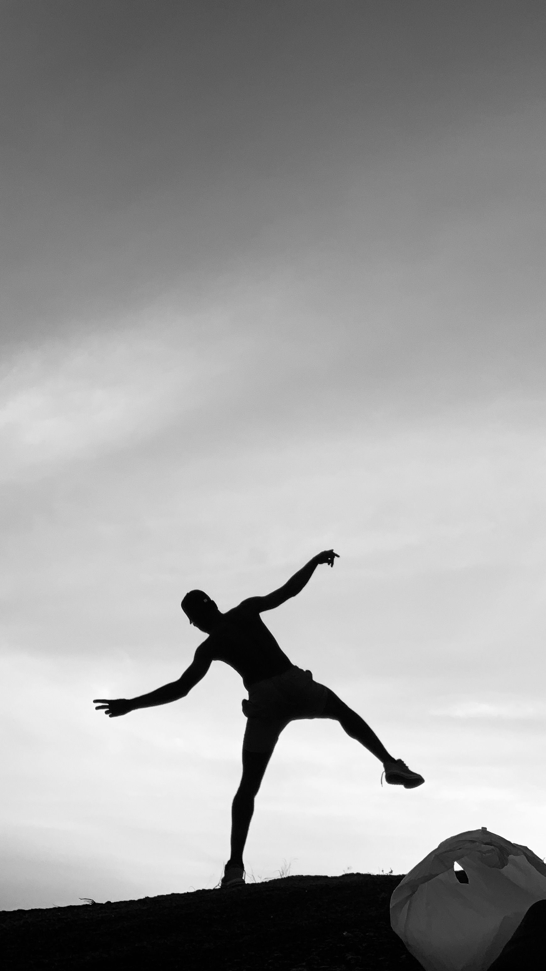 Silhouette of Person Balancing on Edge at Sunset · Free Stock Photo