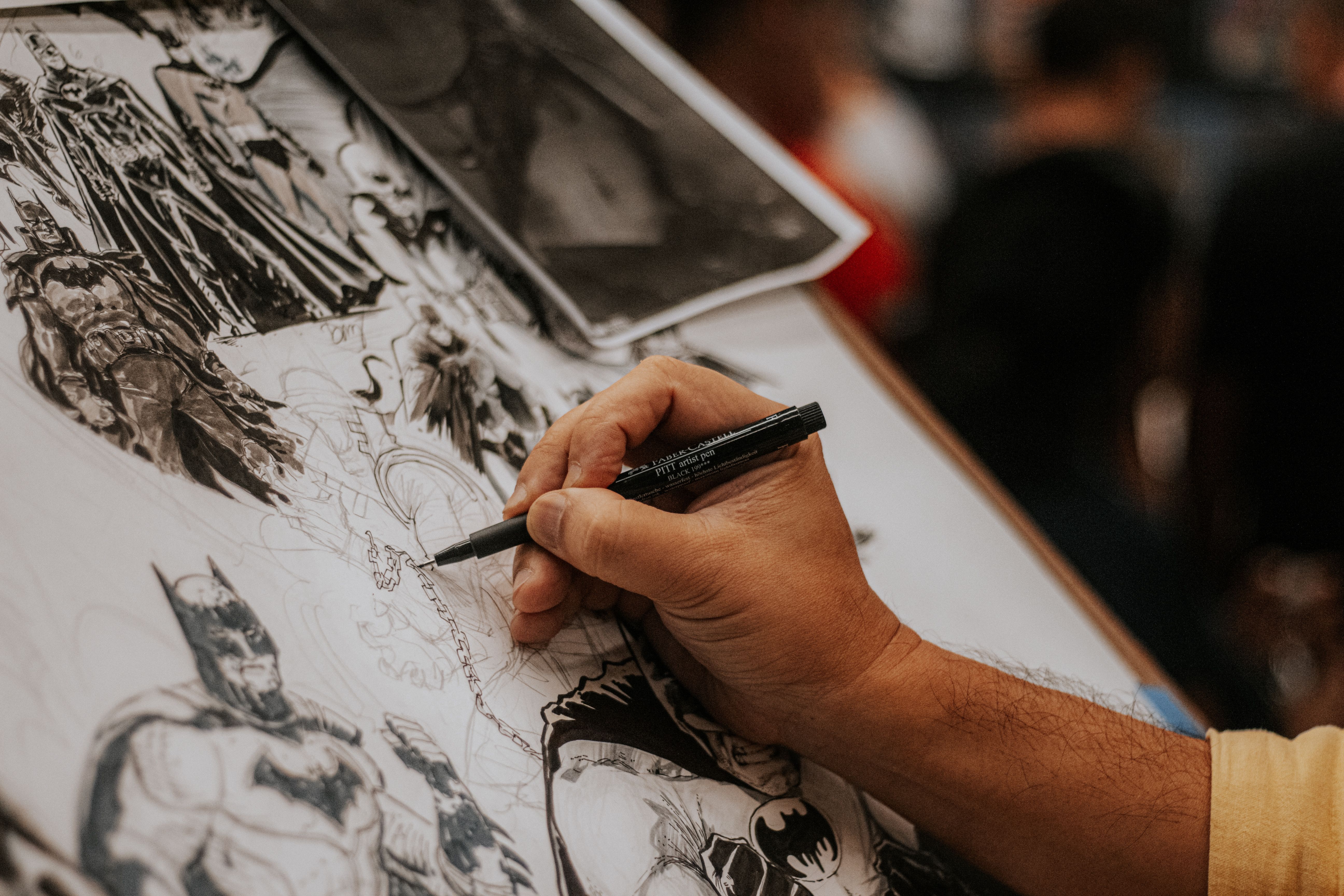 Artist Sketching Comic Book Characters at Event · Free Stock Photo