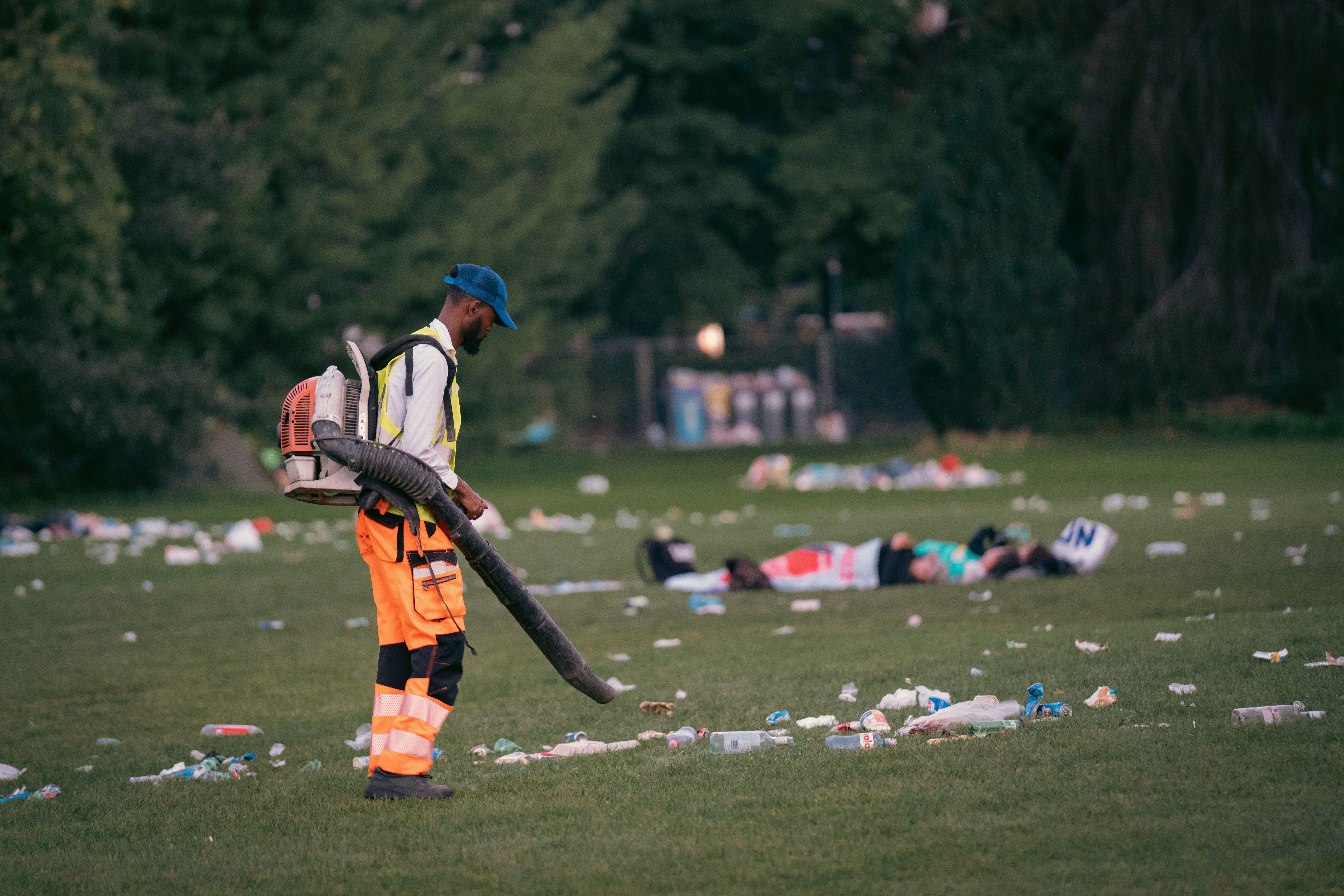 Park Cleanup After Event with Worker Clearing Litter · Free Stock Photo