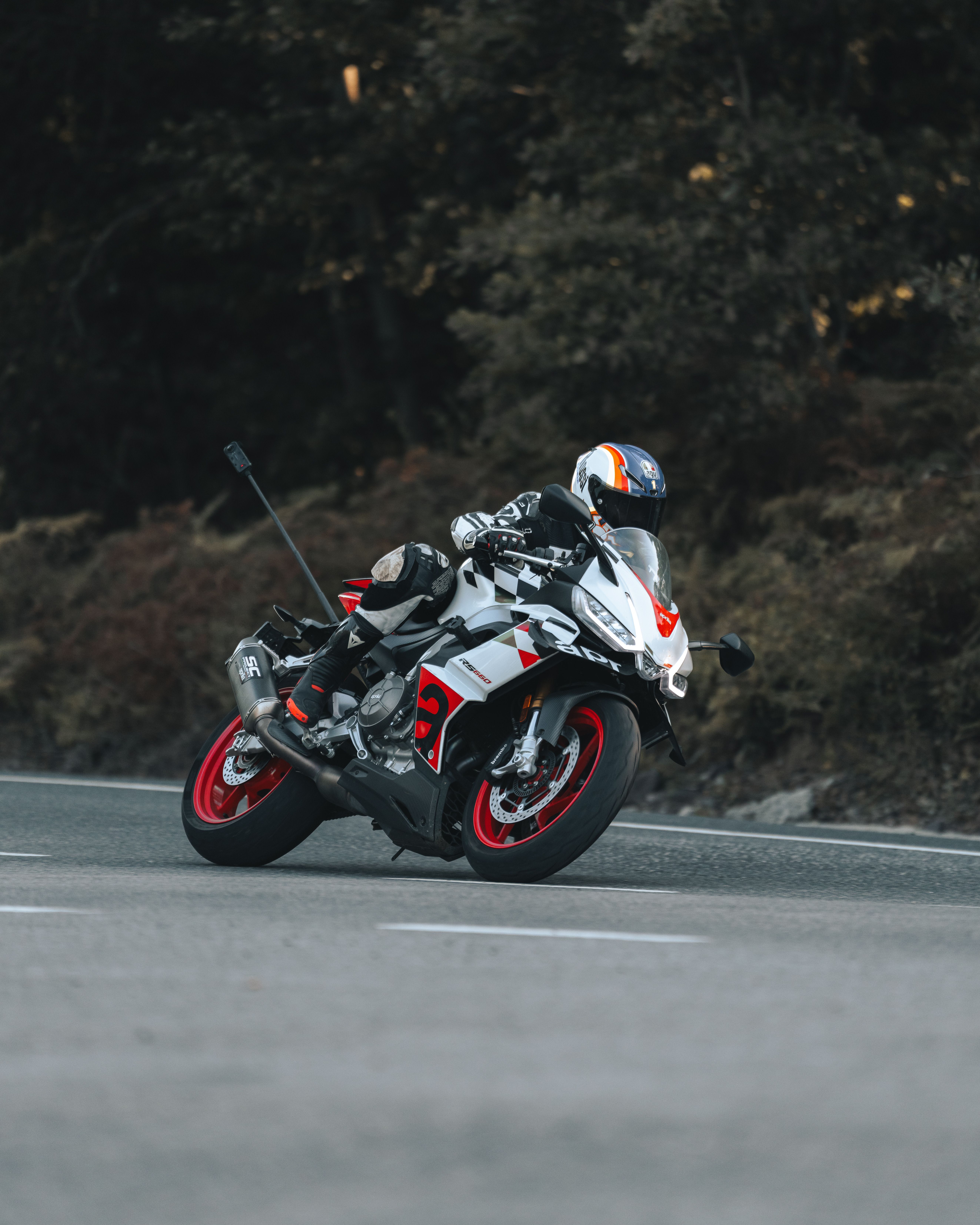 Dynamic Motorcycle Racer Taking a Sharp Turn Outdoors · Free Stock Photo