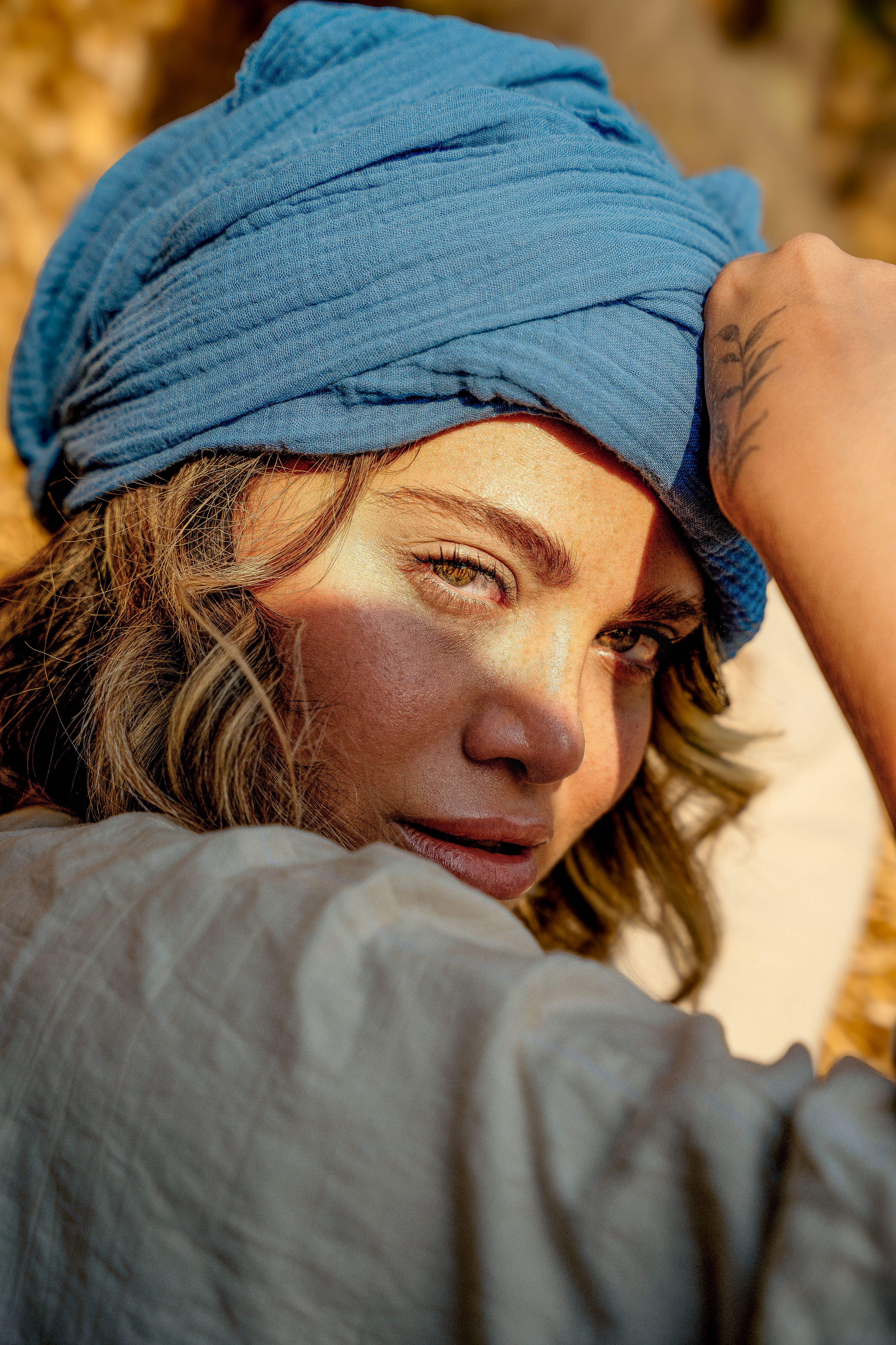 Portrait of a Woman in Blue Scarf with Sunlit Face · Free Stock Photo