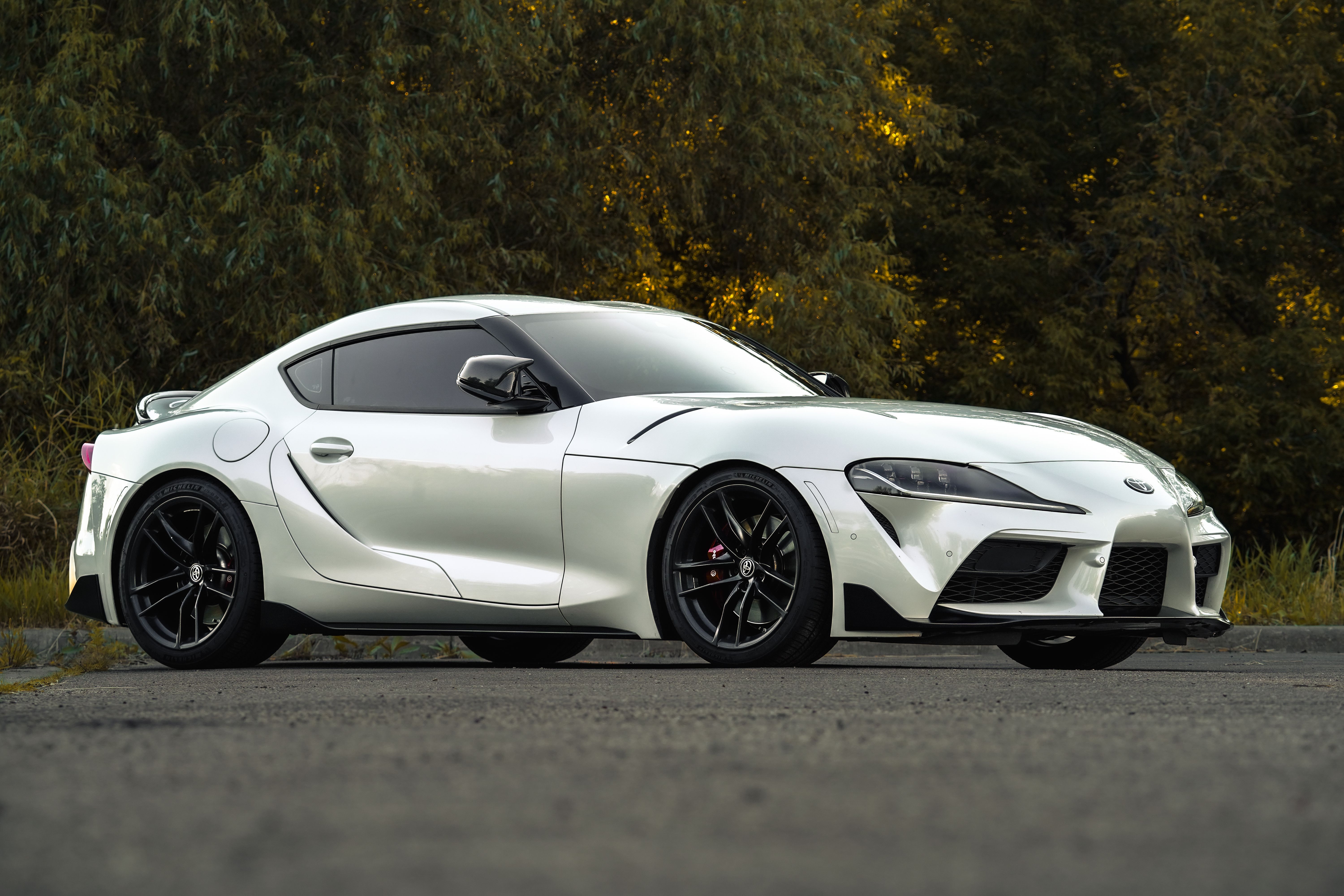 Sporty Silver Car on Asphalt Road in Nature Setting · Free Stock Photo