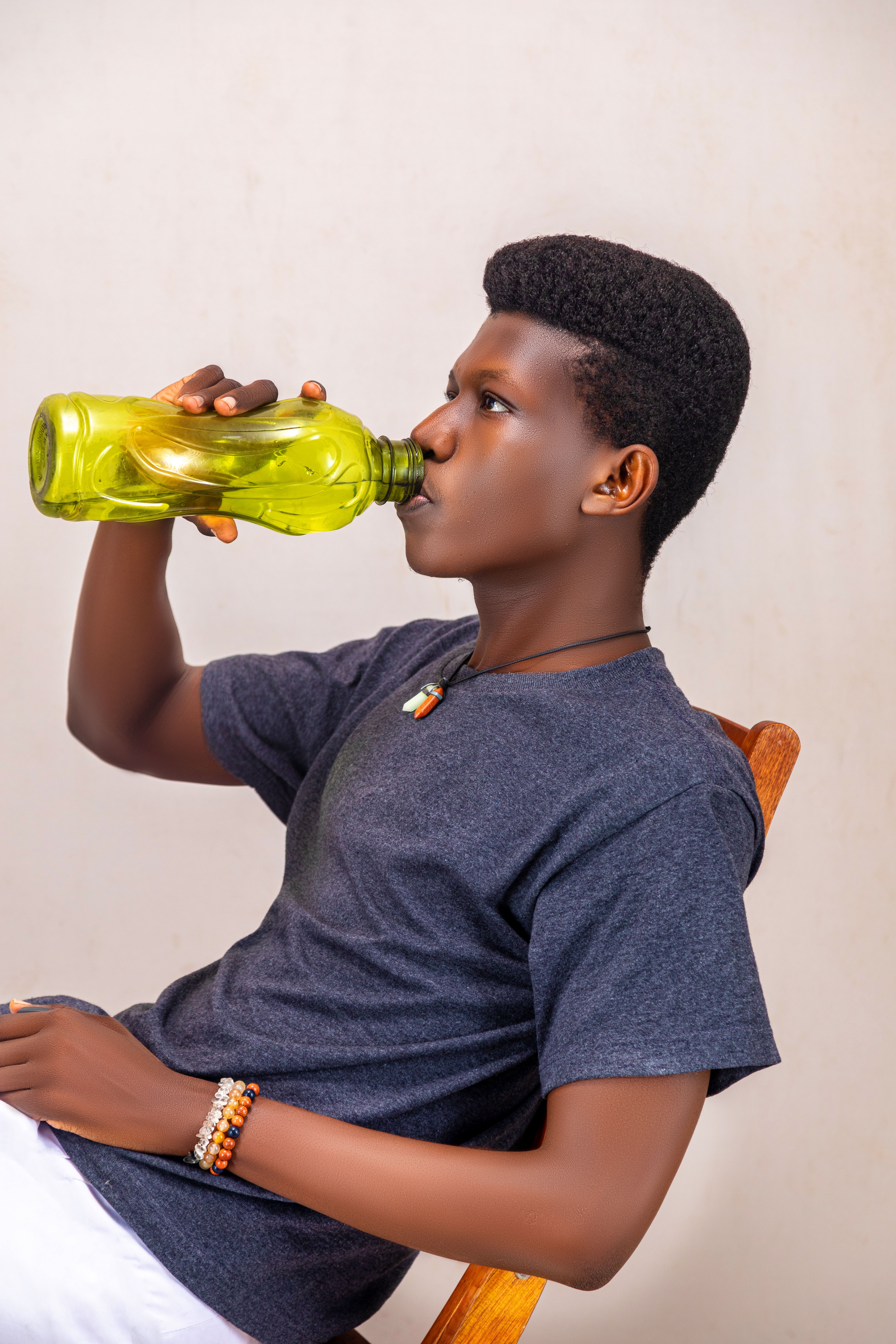 Young Man Staying Hydrated with Water Bottle · Free Stock Photo
