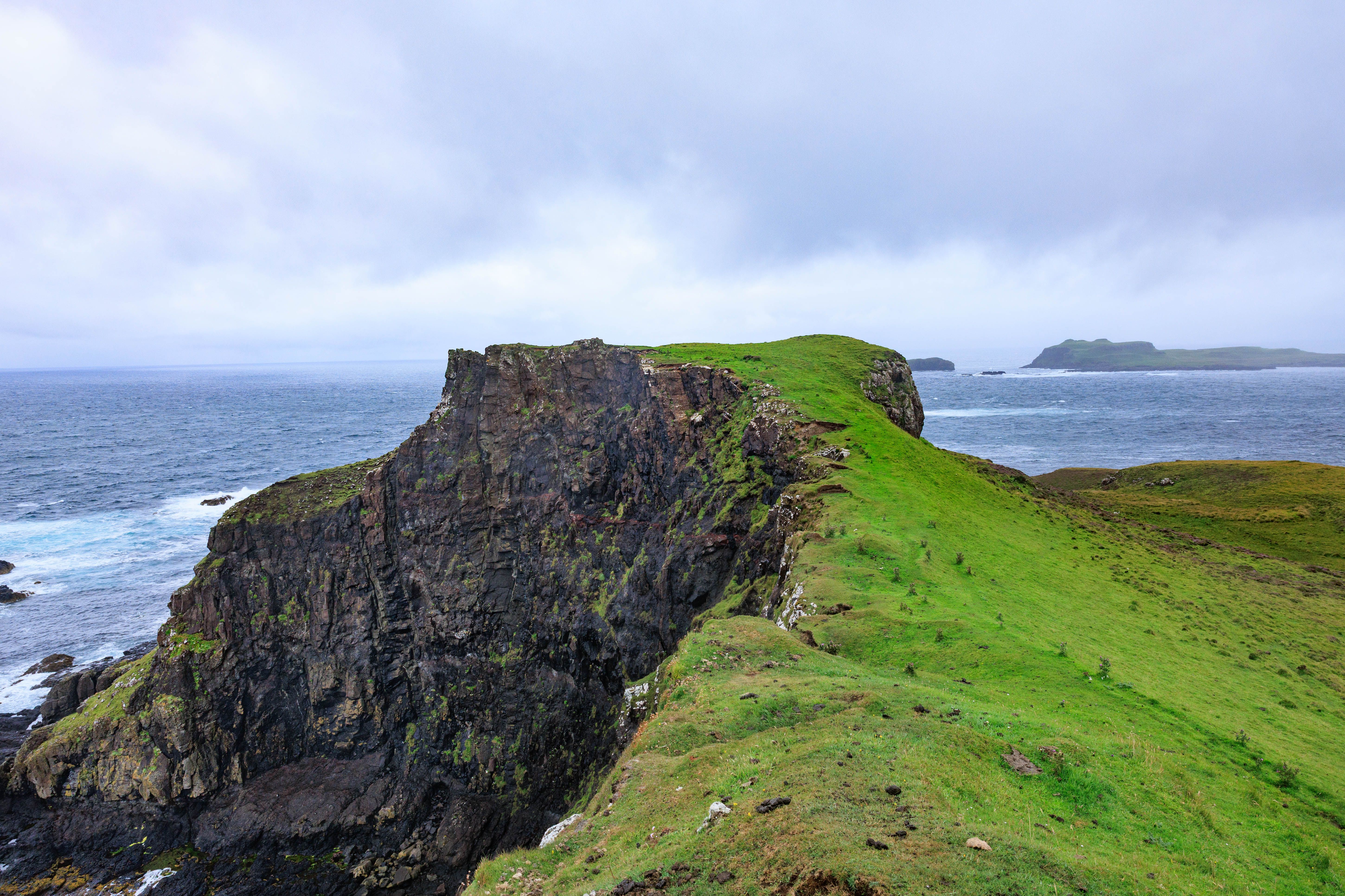 Dramatic Cliffs Overlooking Ocean on a Cloudy Day · Free Stock Photo