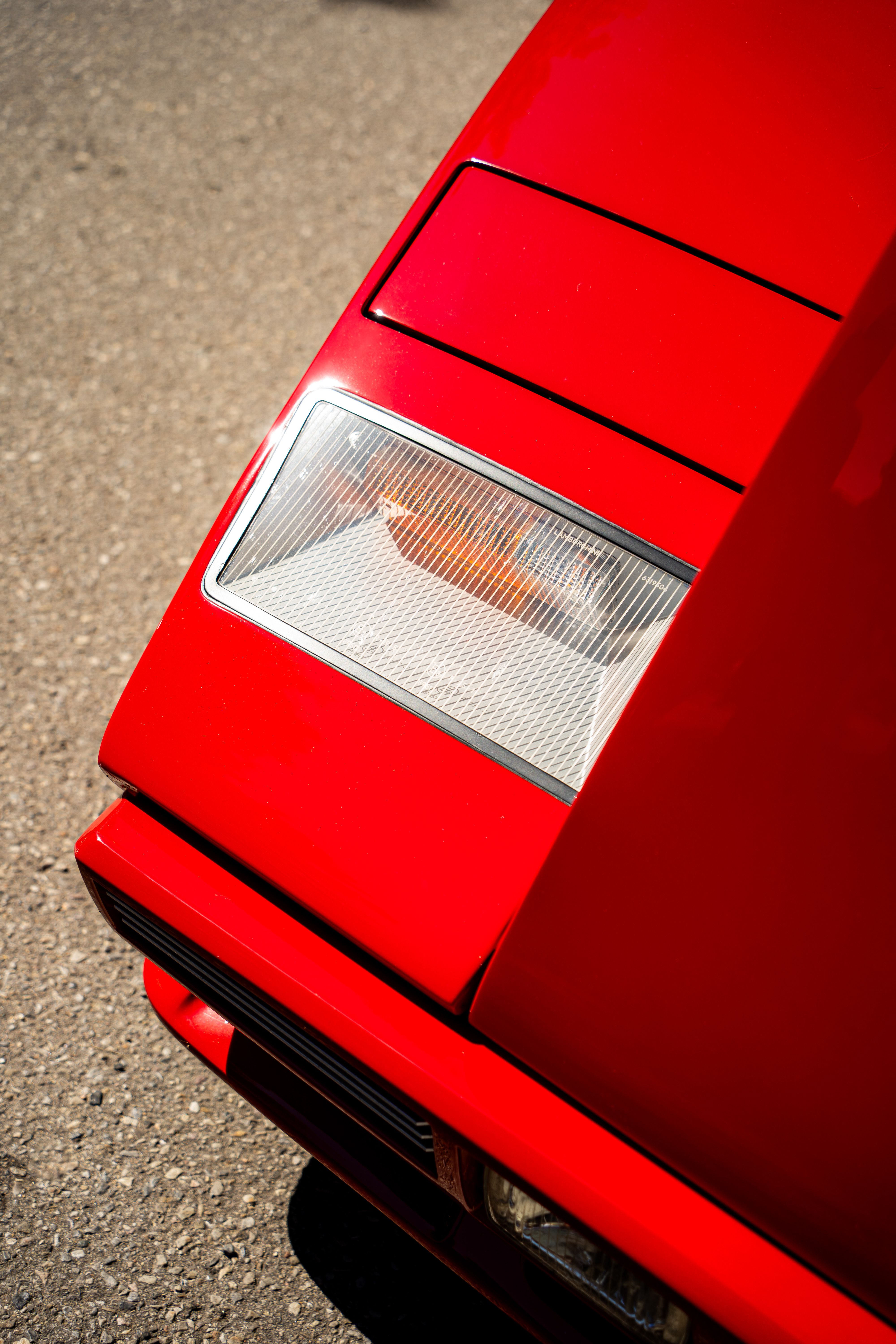 Close-up of Vintage Red Sports Car Headlight · Free Stock Photo