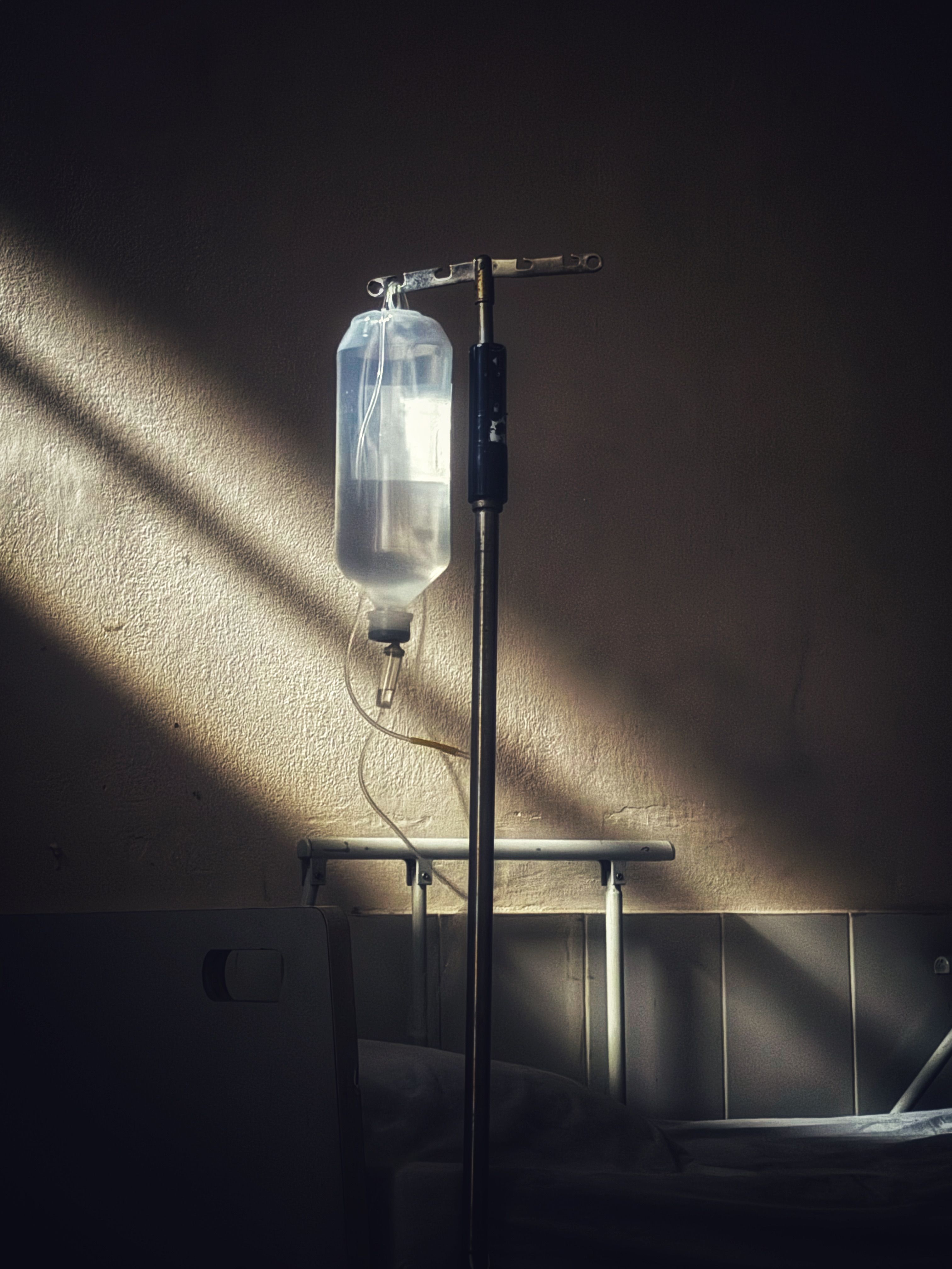 IV Drip Stand in a Dimly Lit Hospital Room · Free Stock Photo
