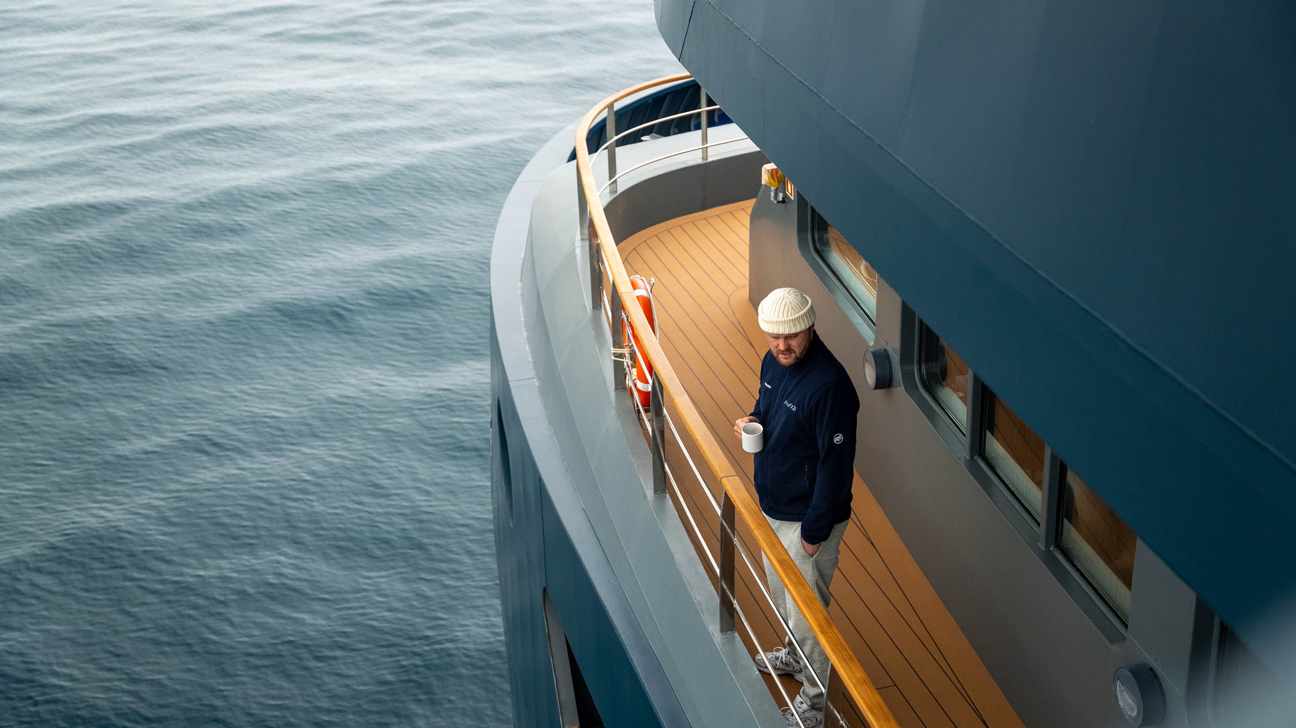 Man on Yacht Deck with Coffee at Sea · Free Stock Photo