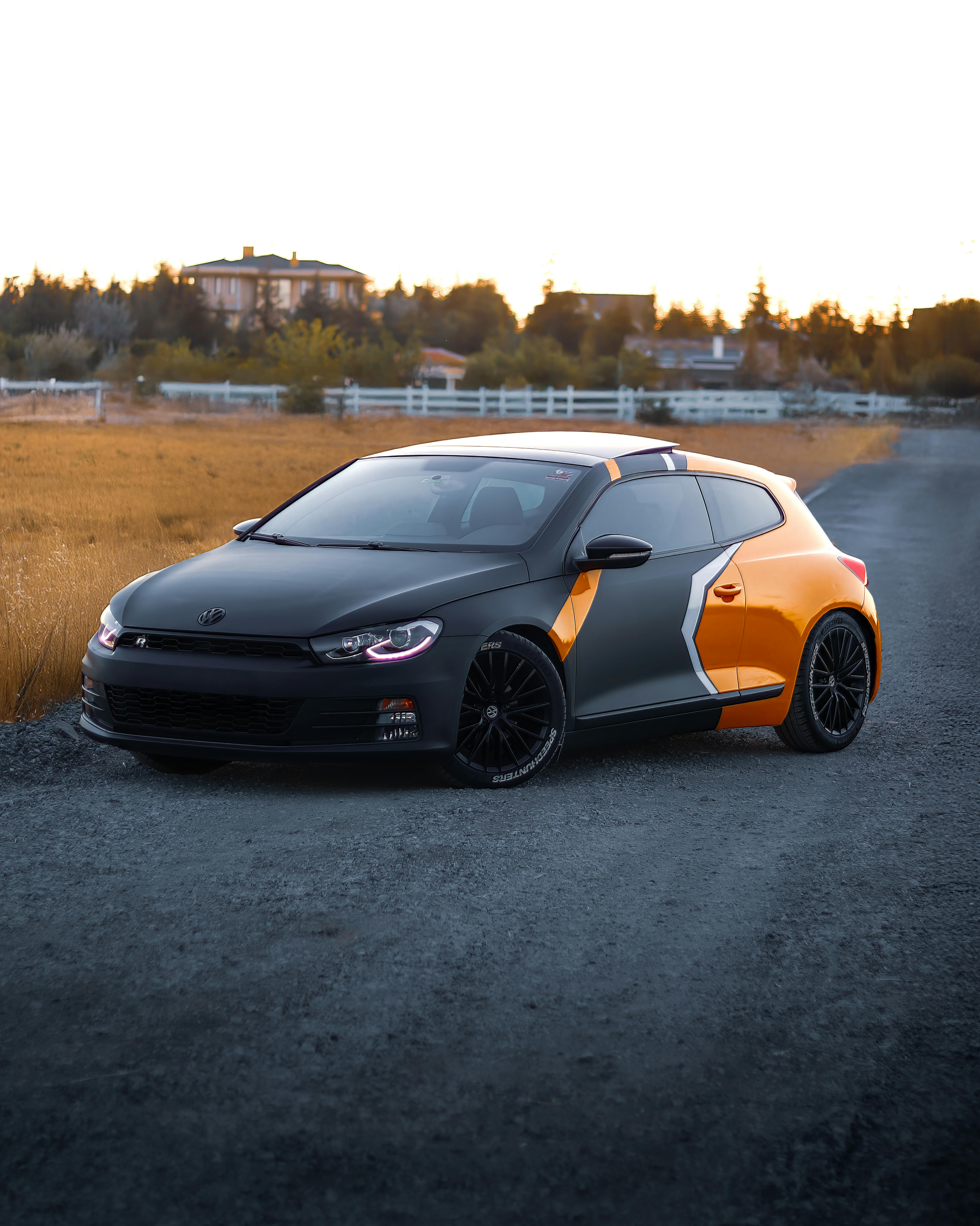 Free A sleek and modern hatchback car parked on a rural road at sunset ...