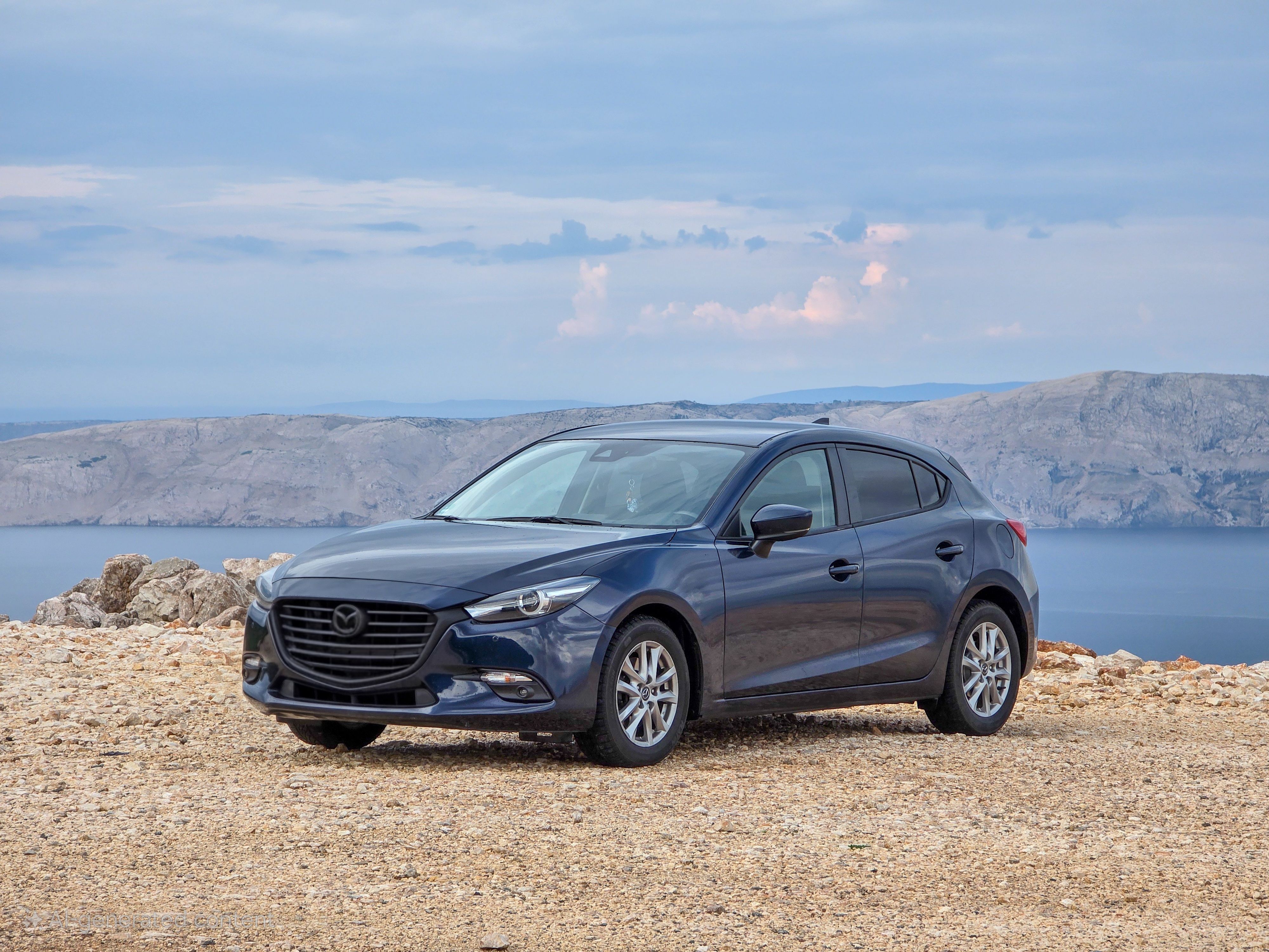 Blue car parked on rocky coastal landscape · Free Stock Photo